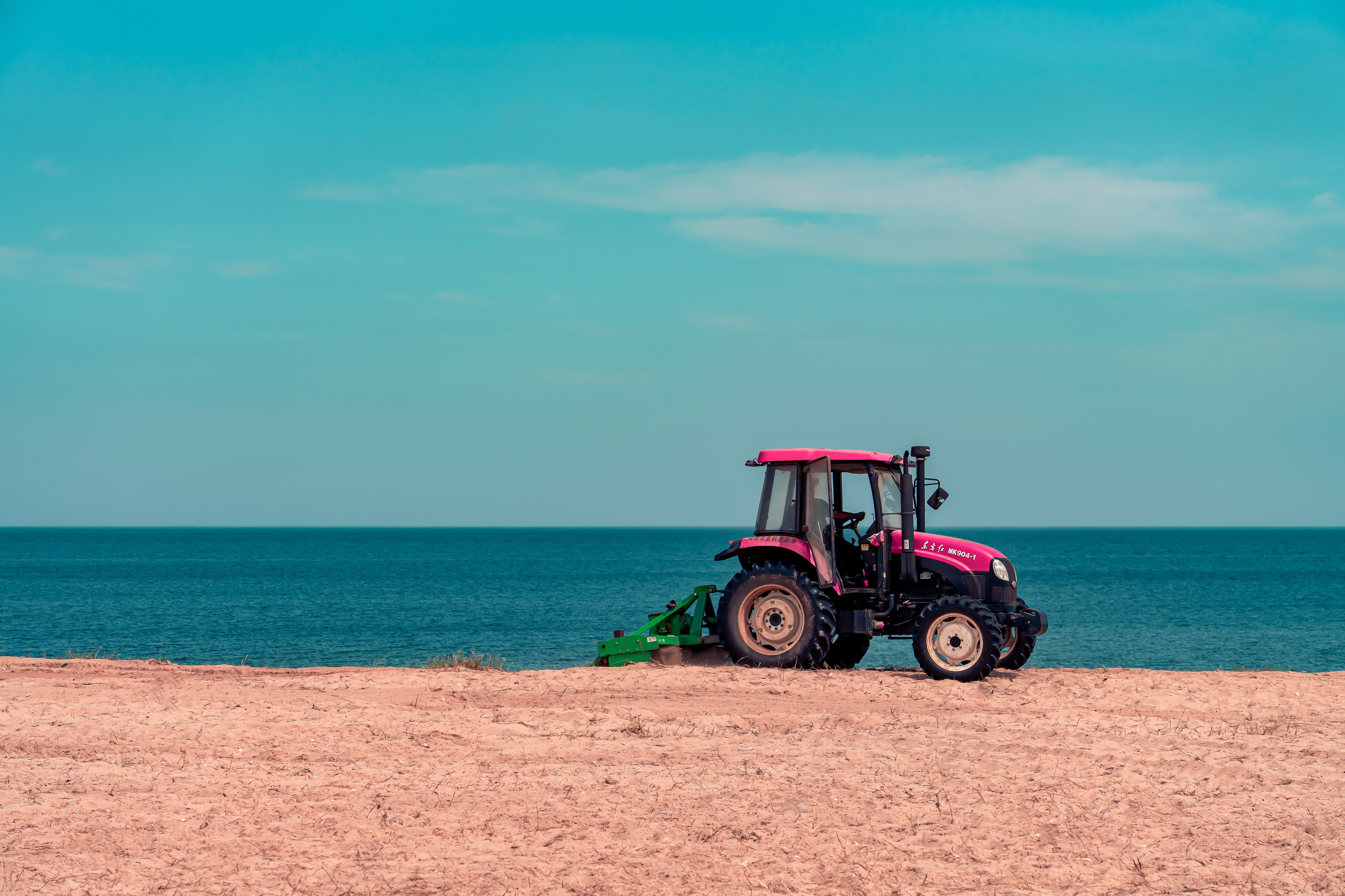 Photo of a Red Tractor on a Sandy Beach against a Turquoise Sea · Free ...