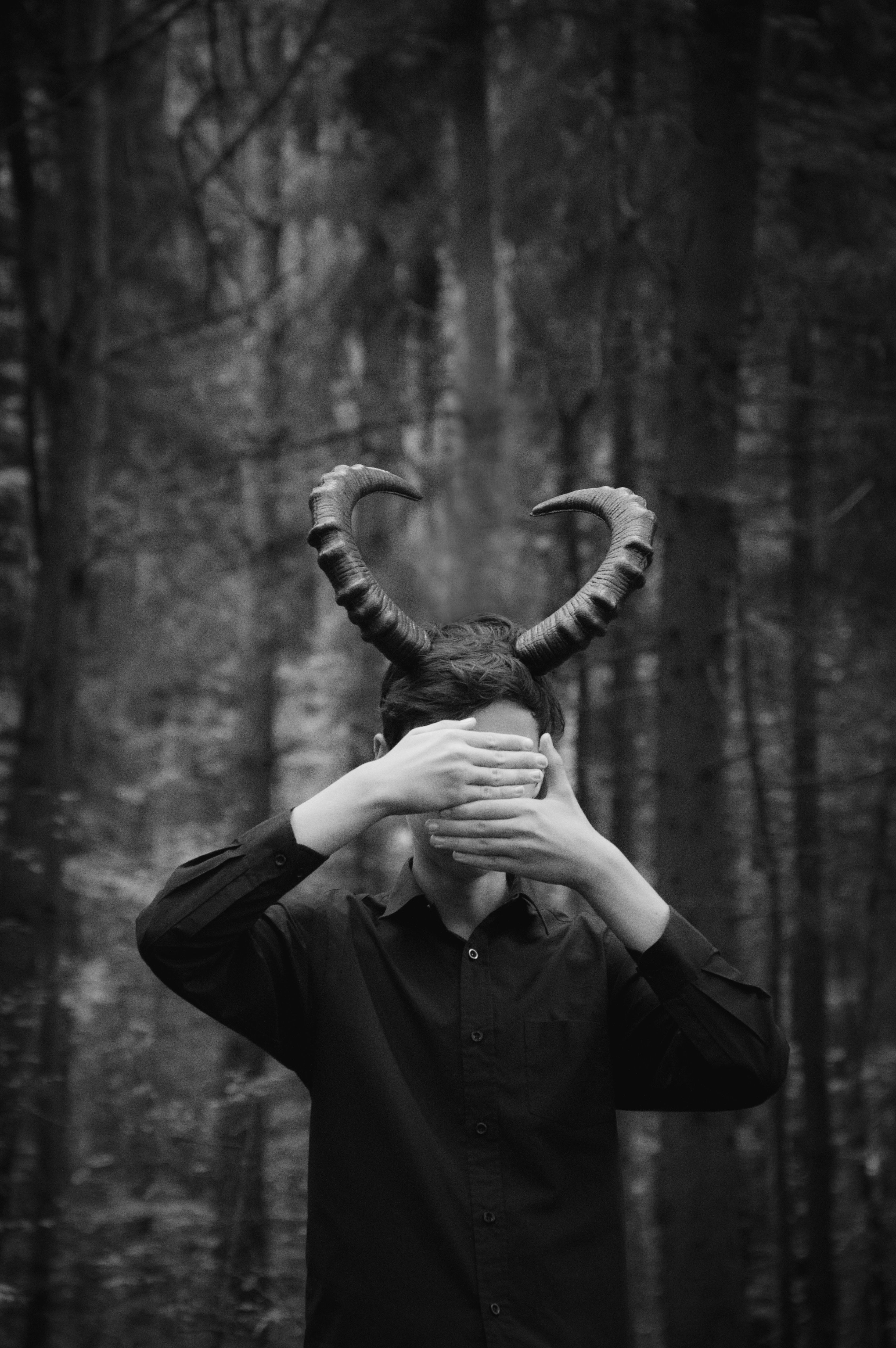 A Man in the Forest Wearing Horns and Covering His Face · Free Stock Photo