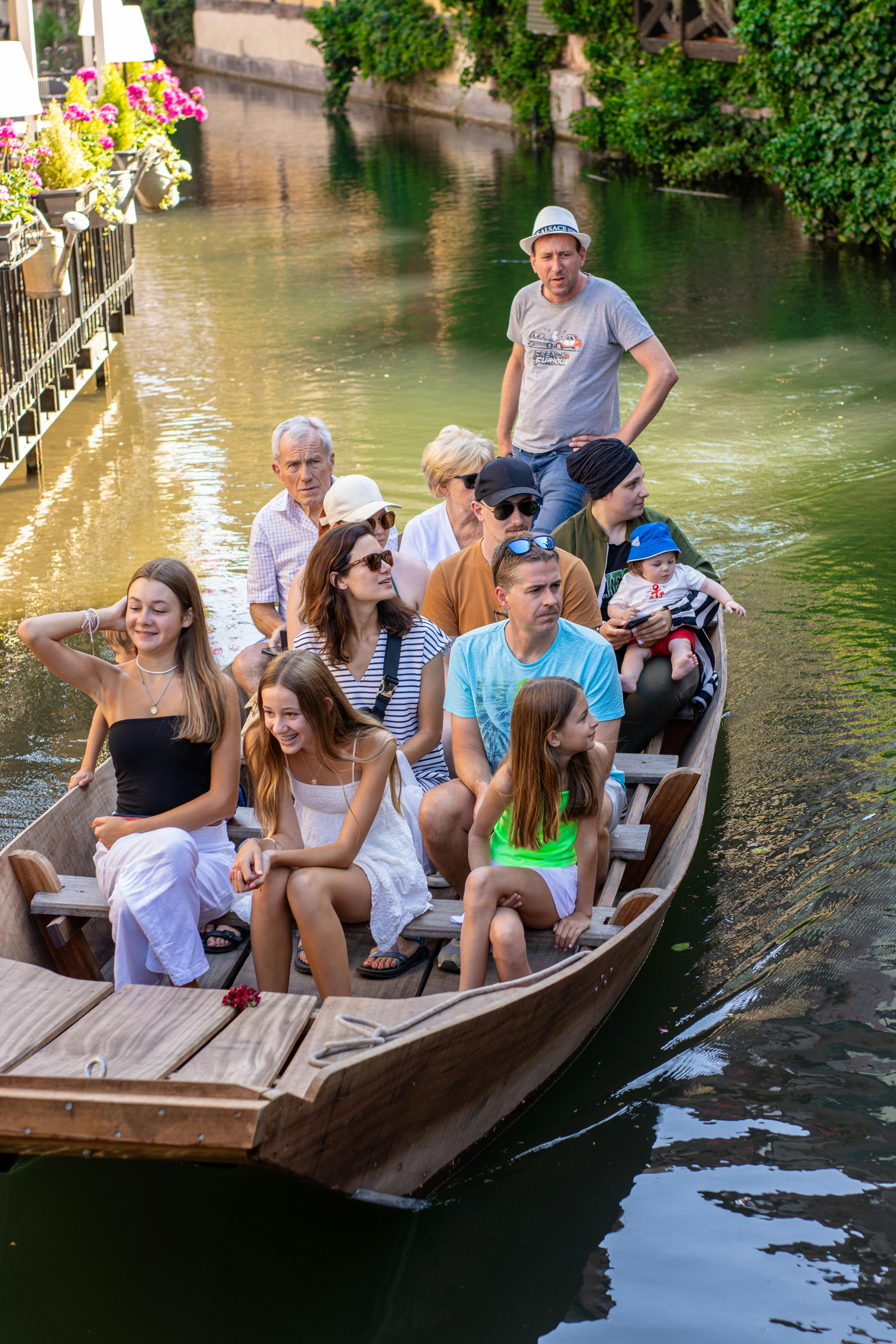 Tourists Carried on a Wooden Boat Along the Canal · Free Stock Photo