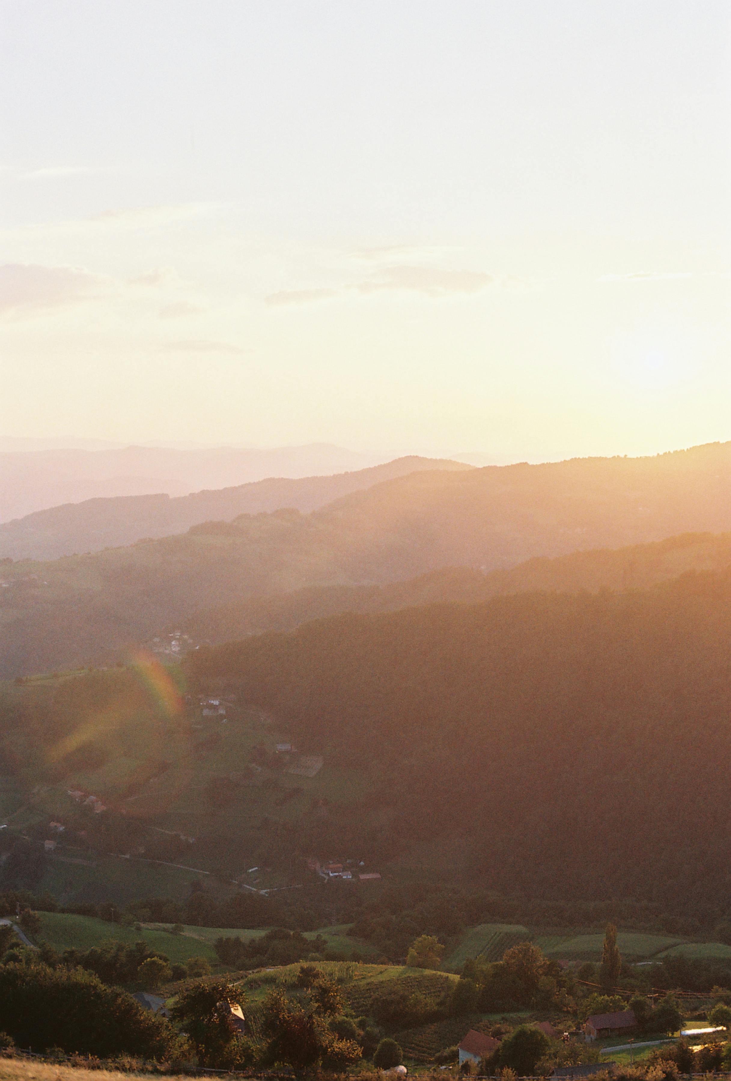 Sunset Sunlight over Hills · Free Stock Photo