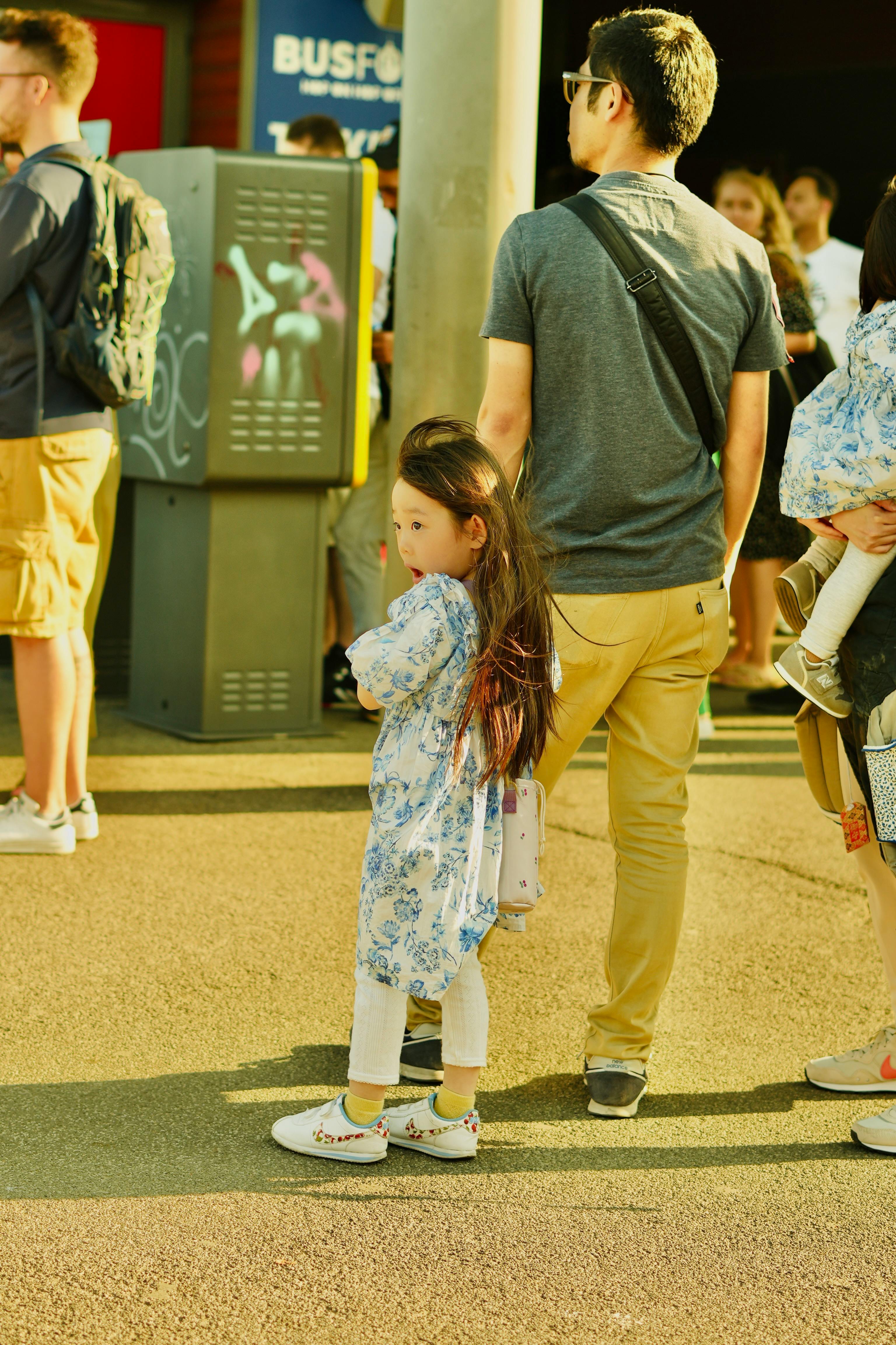 Father and Daughter Standing in Queue · Free Stock Photo