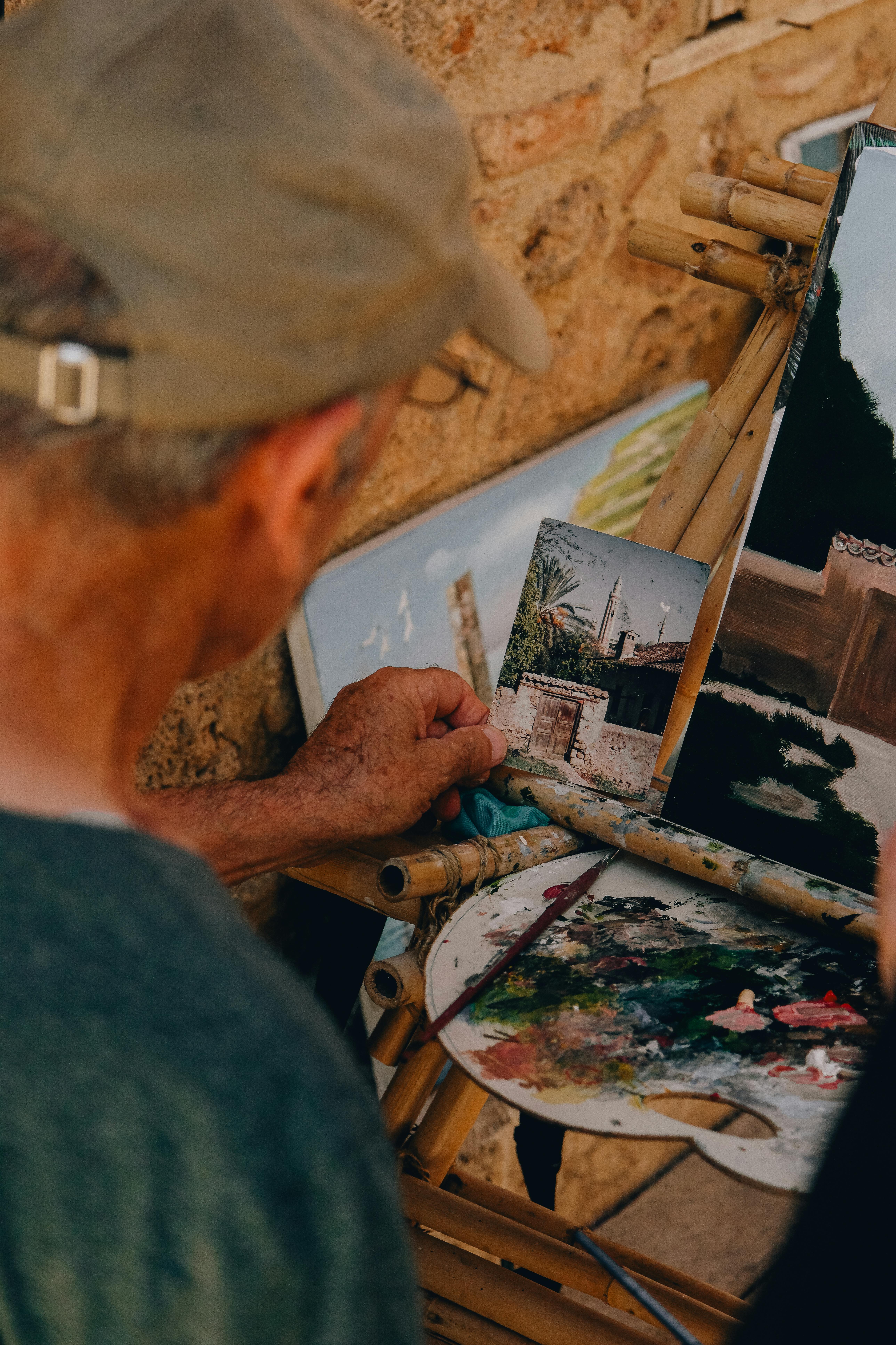 Back View of Artist and Paintings · Free Stock Photo
