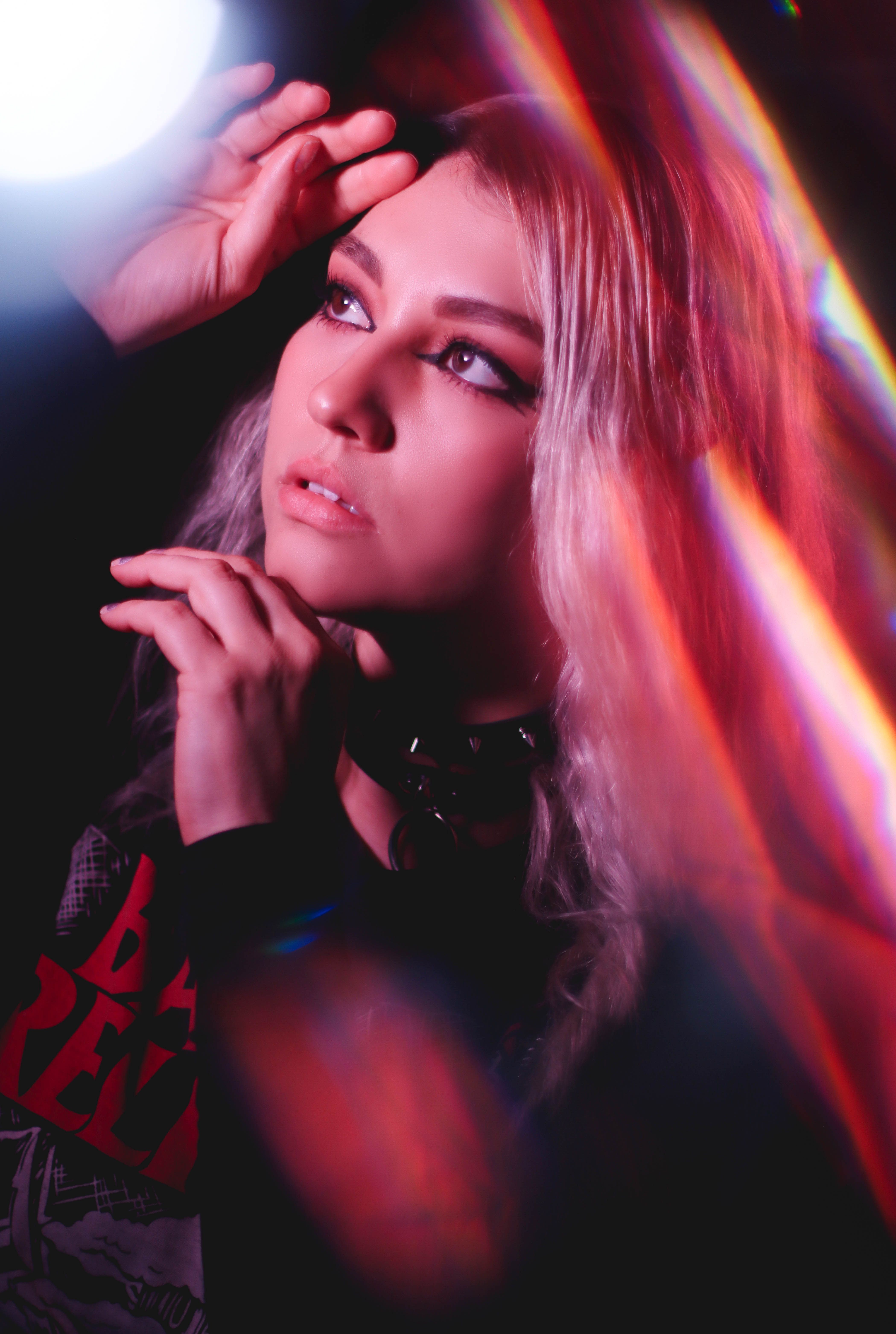 Studio Shot of a Young Woman in Pink Lighting · Free Stock Photo