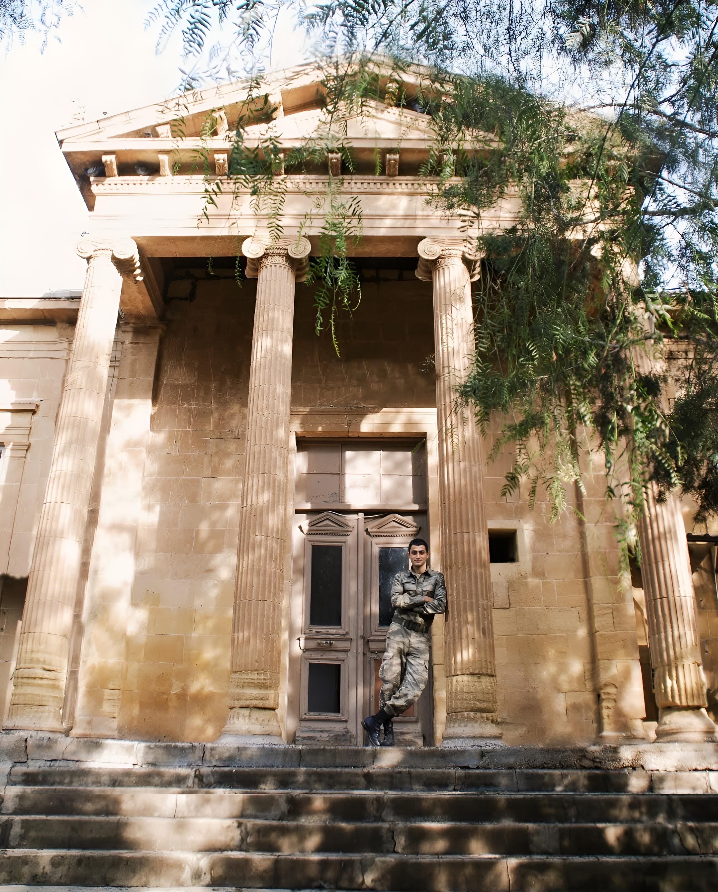 Man Standing behind Stairs to Building with Columns · Free Stock Photo