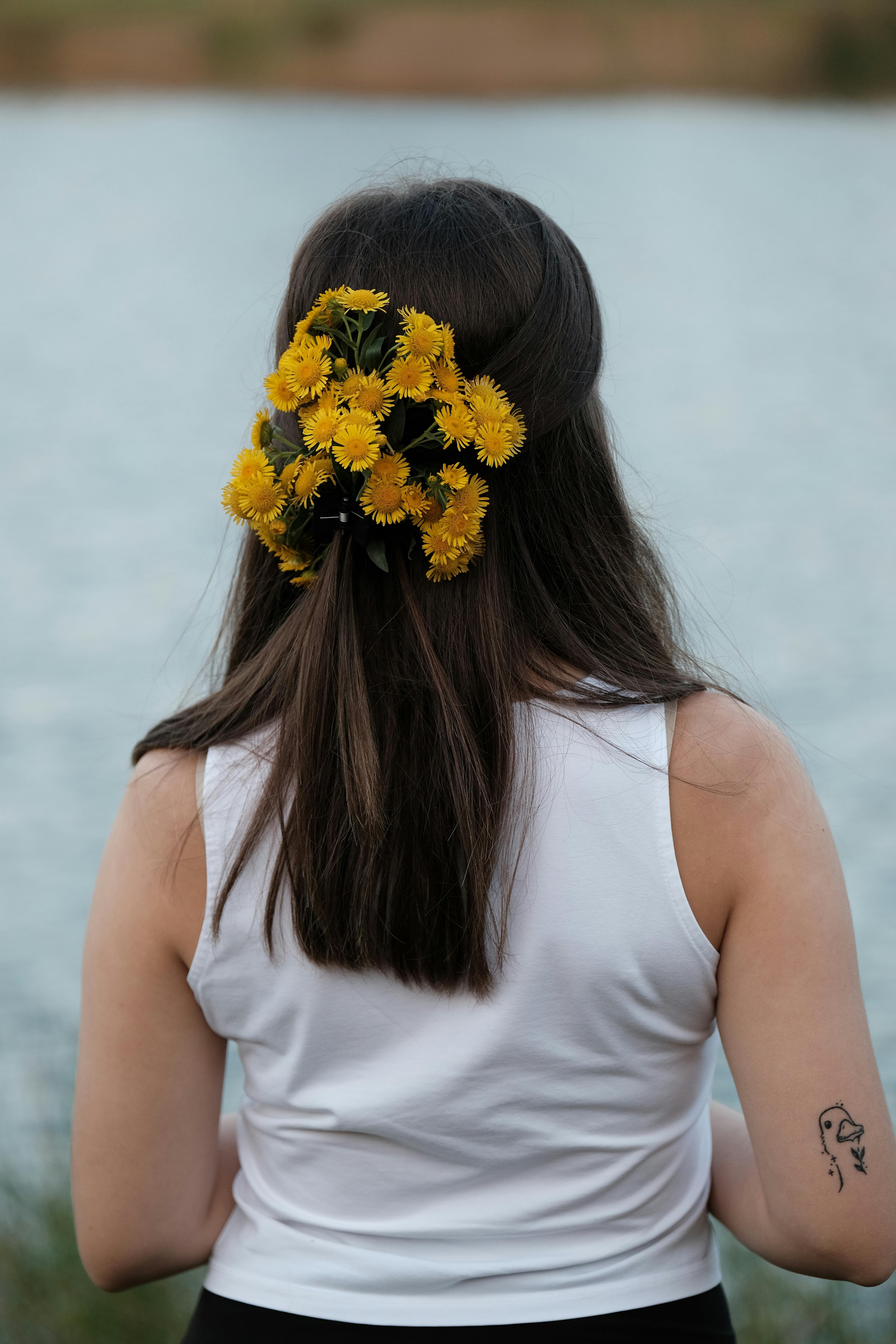 Back View of a Woman with Flowers in Her Hair · Free Stock Photo