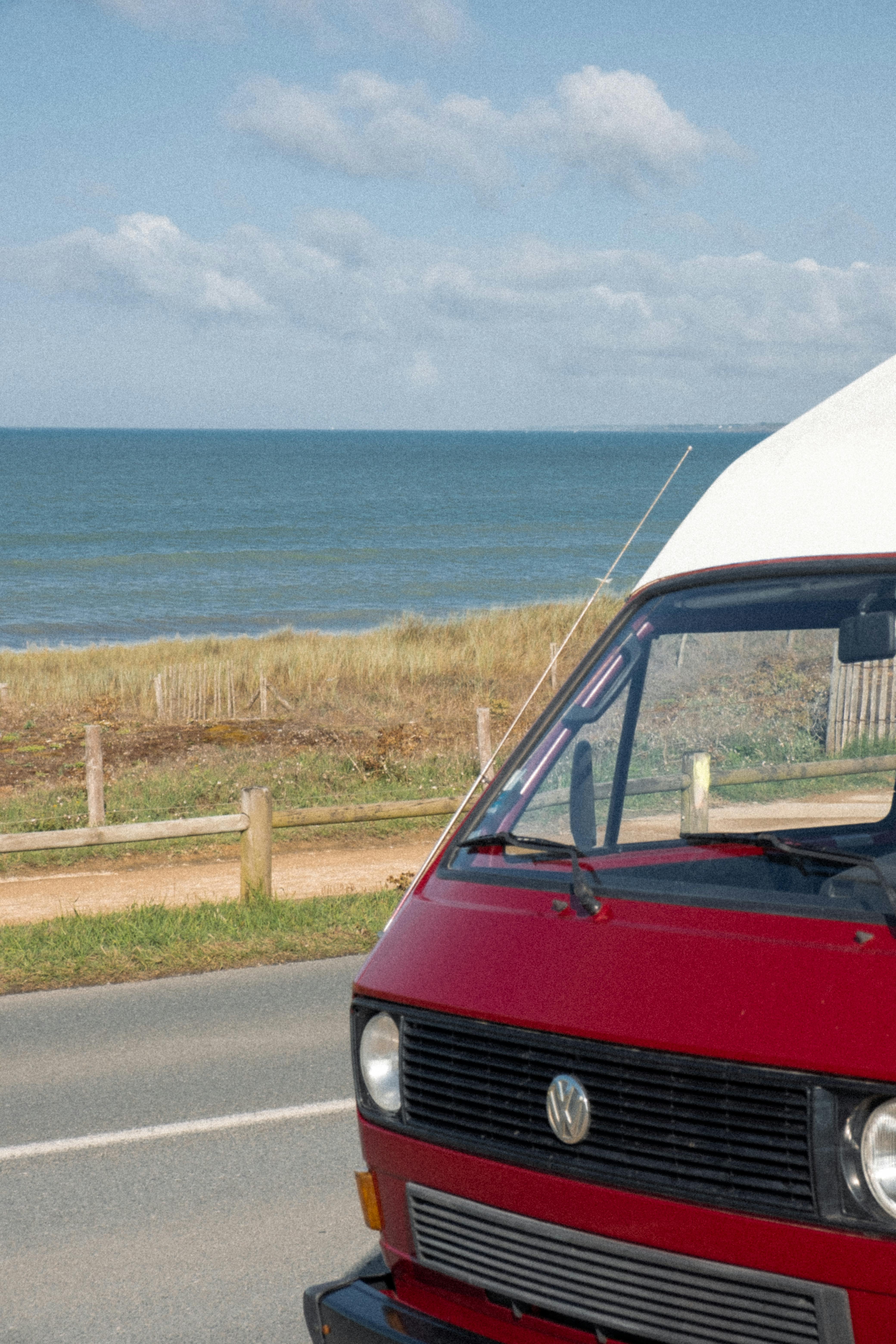 Red Volkswagen Van on Road on Coast · Free Stock Photo