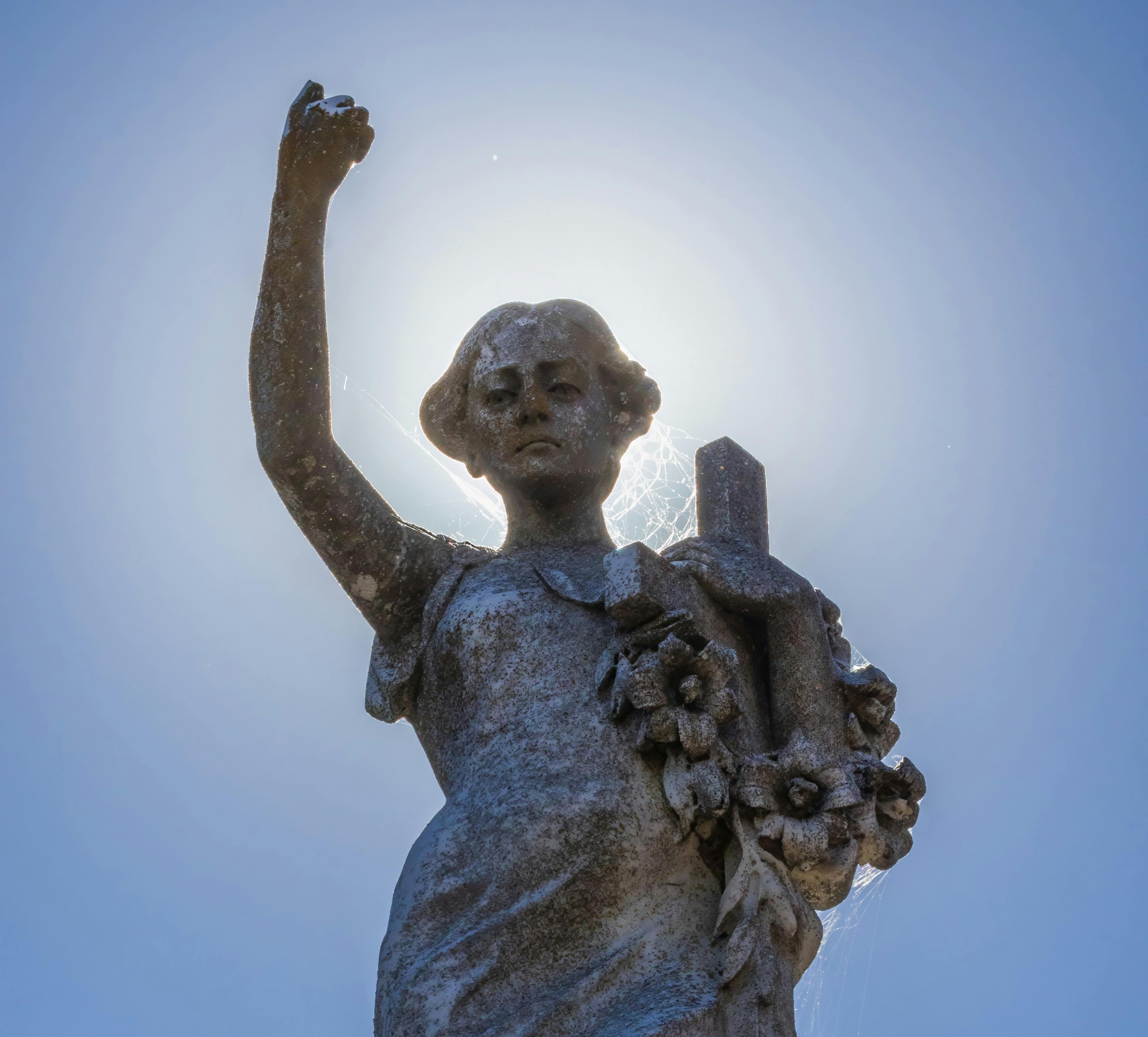 Statue of Standing Woman with Raised Hand · Free Stock Photo
