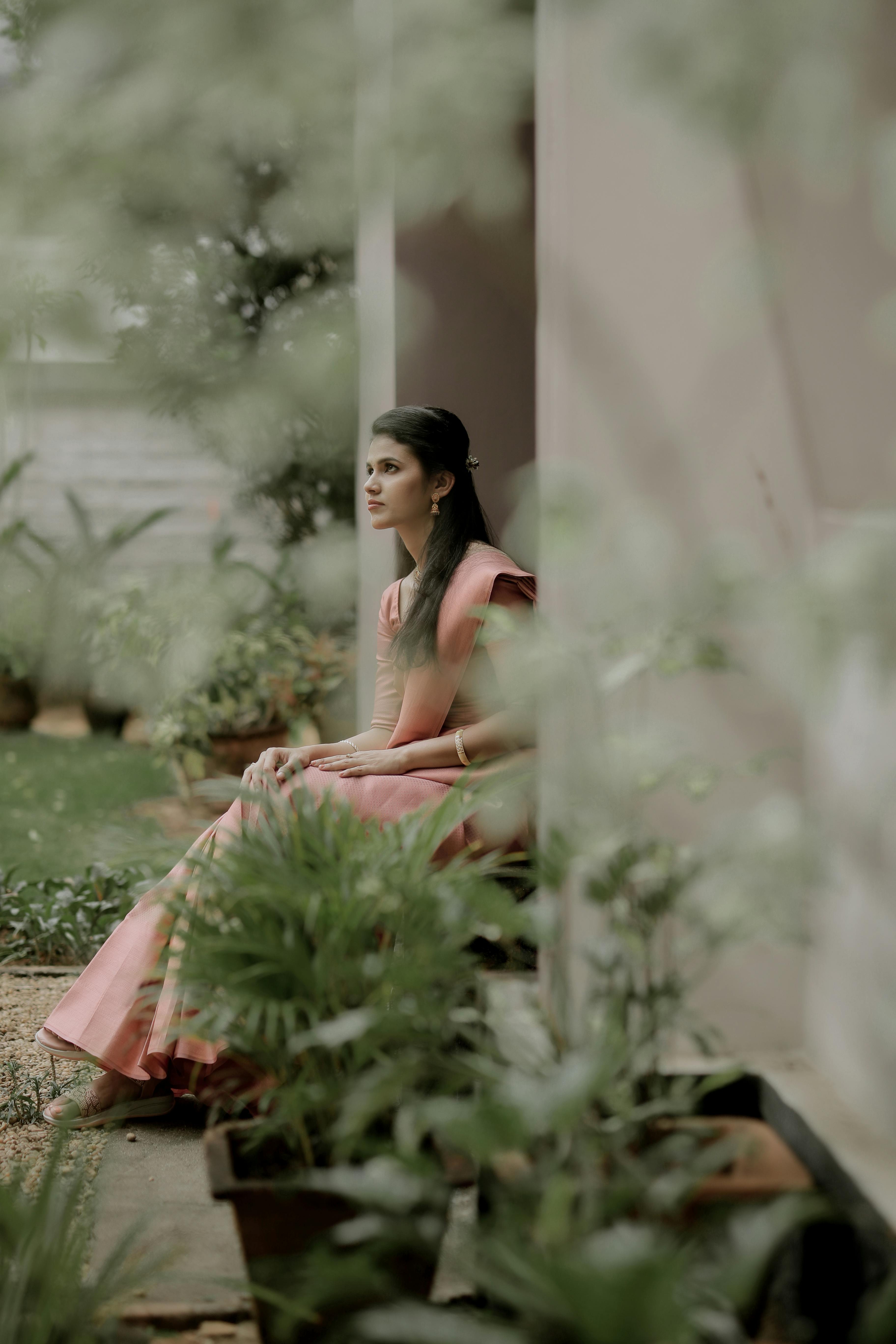 Brunette Woman in Peach Saree Sitting on Steps · Free Stock Photo