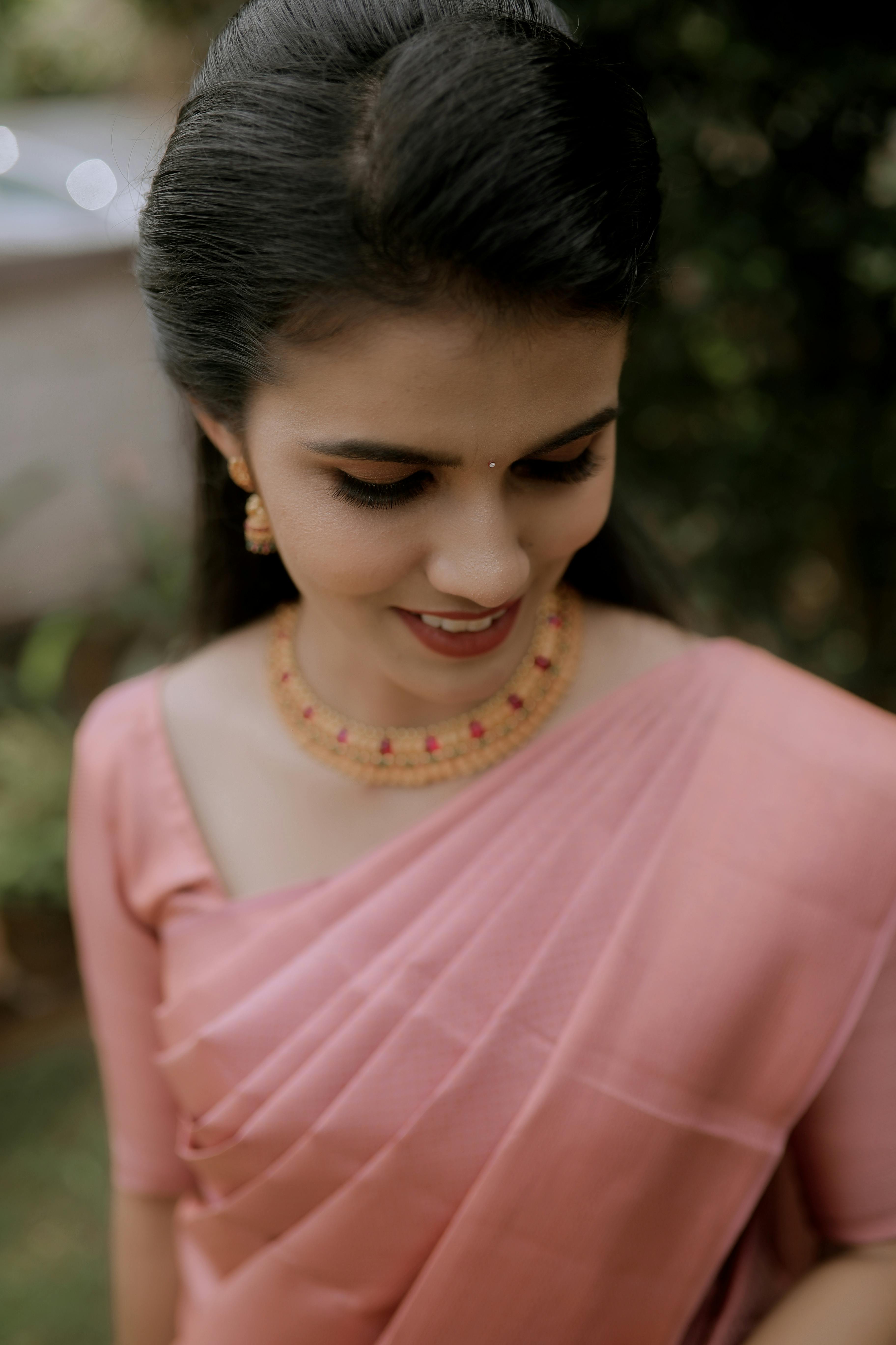 Portrait Of Woman In Pink Dress Standing In Front Of Iron Gate · Free