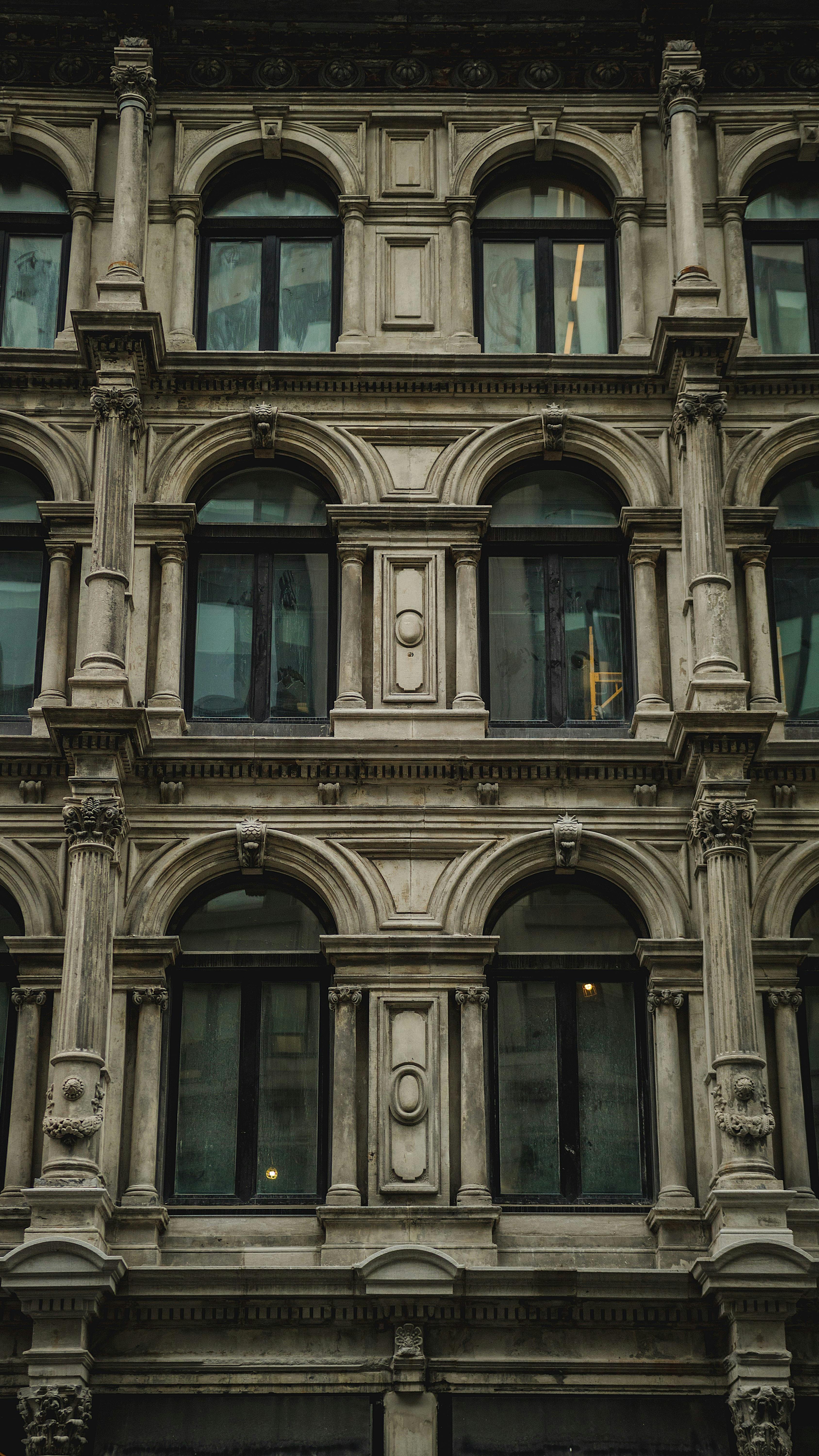 A building with windows and arches on it · Free Stock Photo