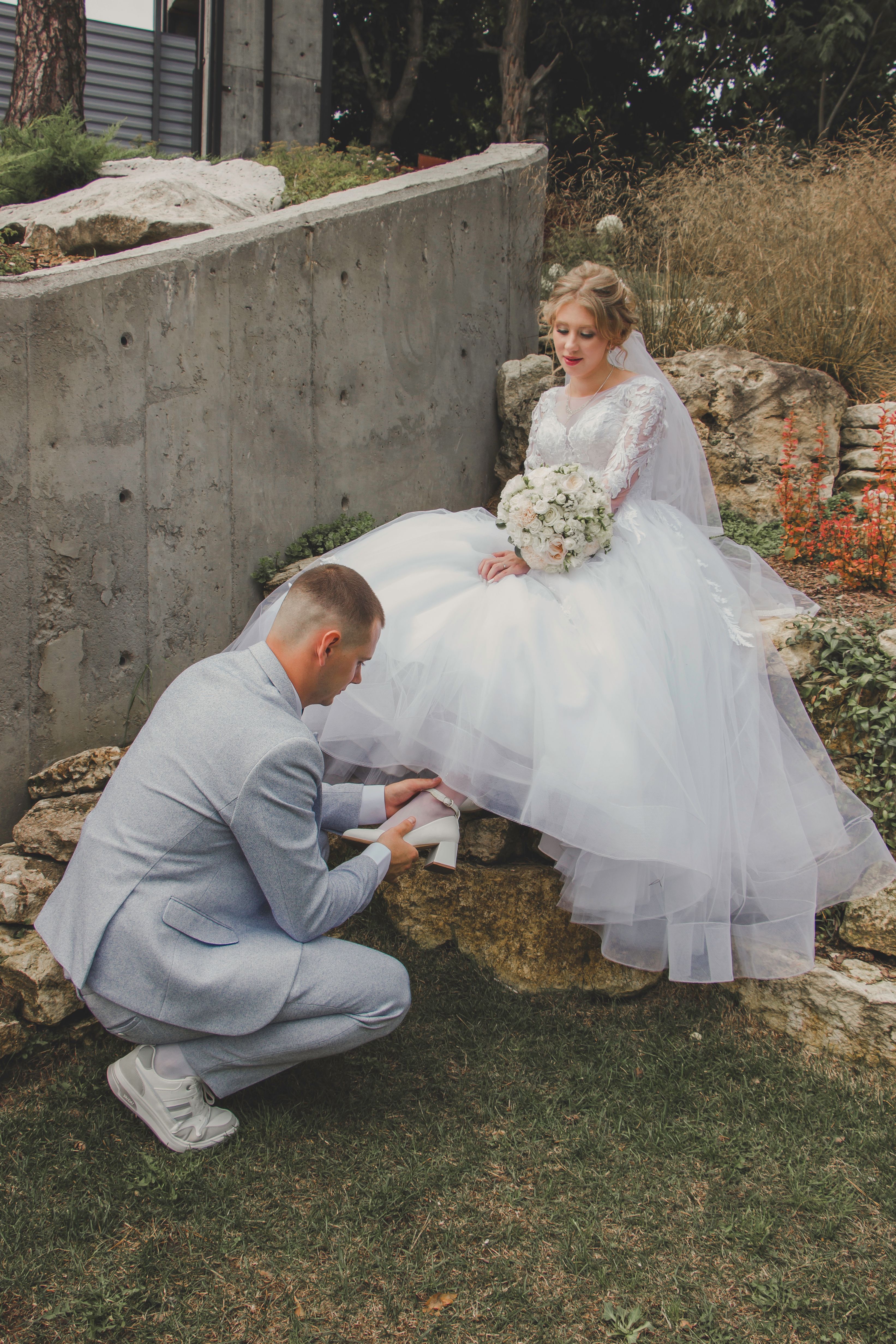The Groom Fixing the Brides Shoe · Free Stock Photo