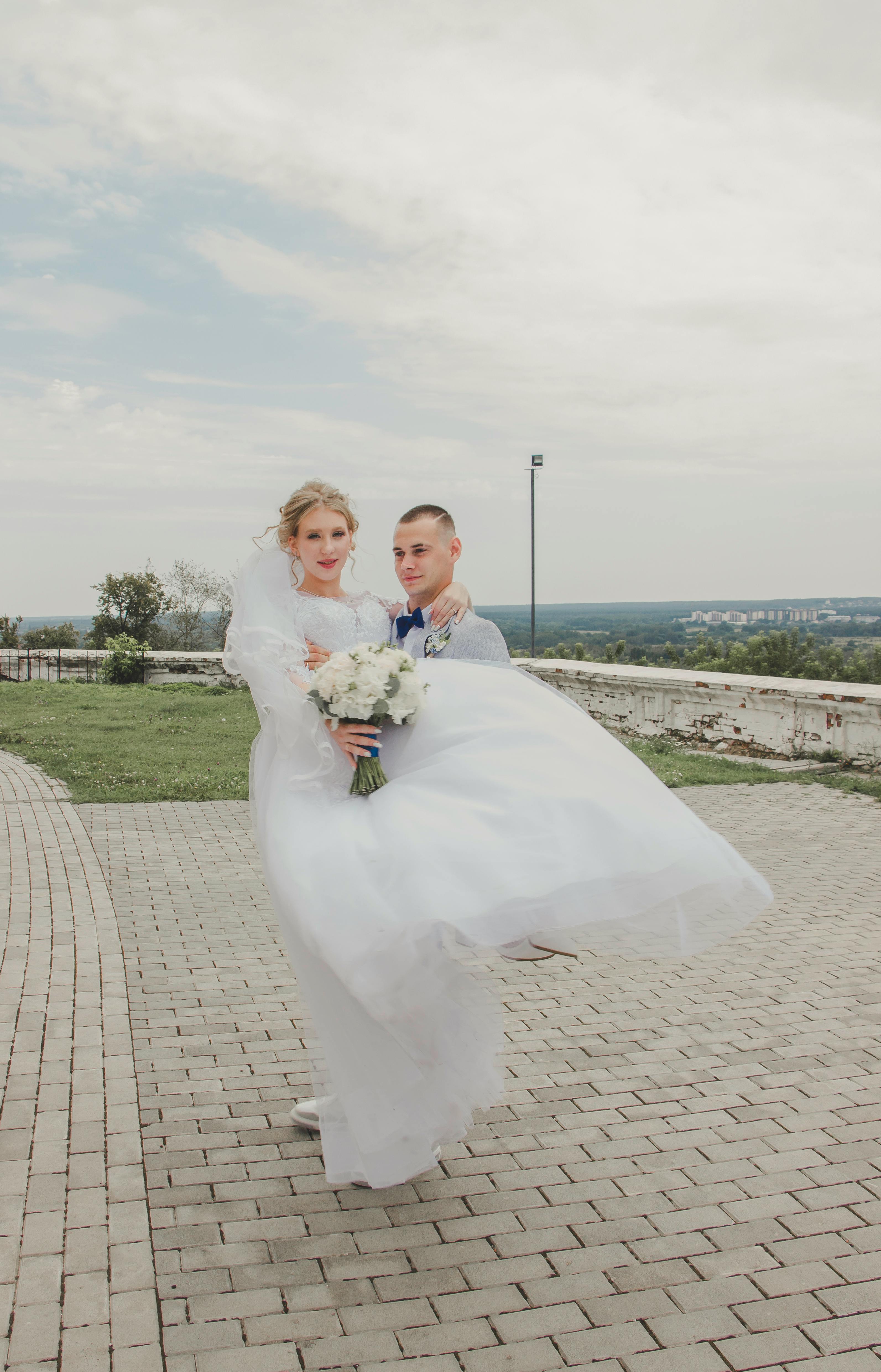Groom Carrying Bride in Arms · Free Stock Photo