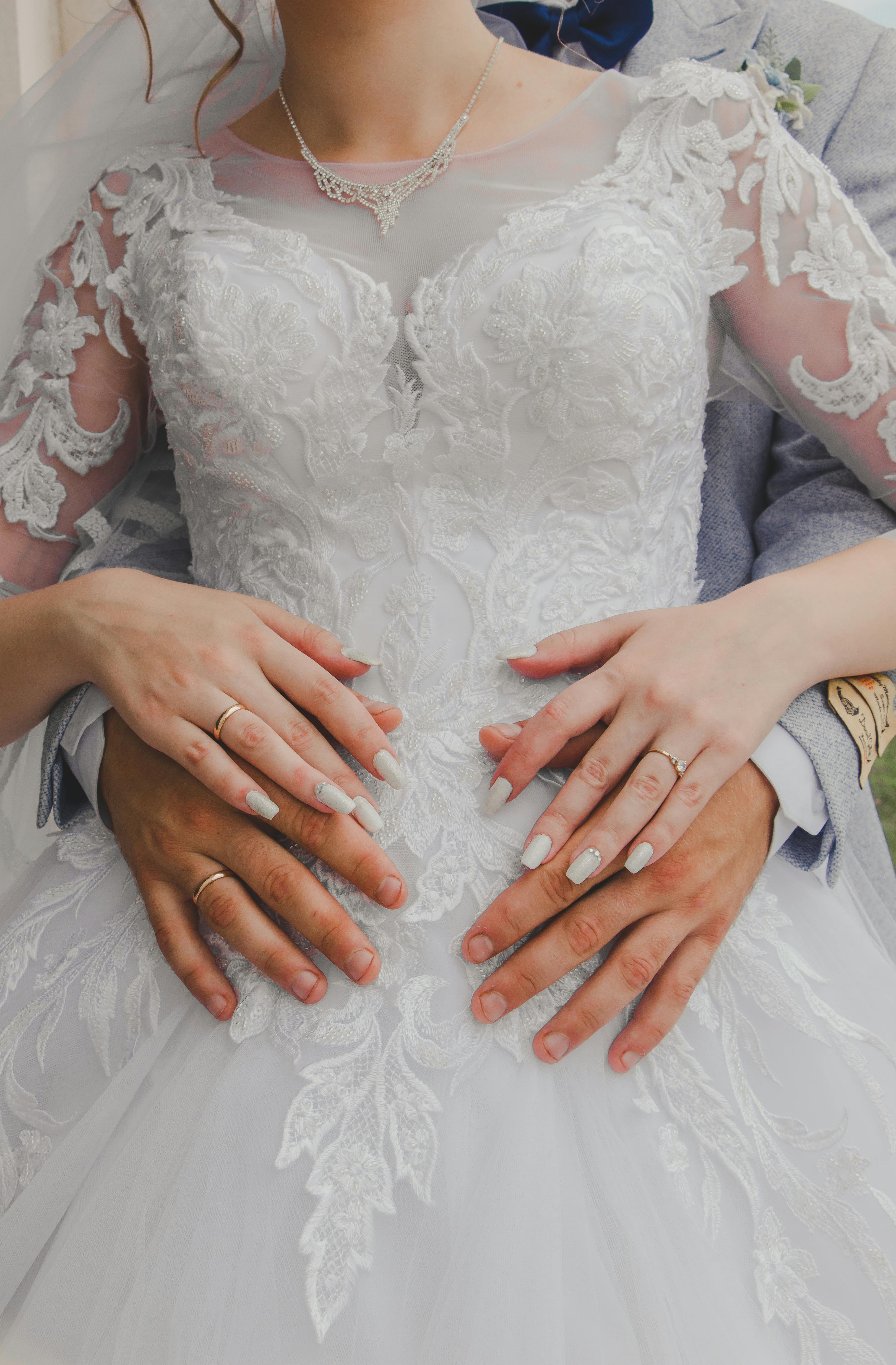 Newlyweds Hands Together on Woman Wedding Dress · Free Stock Photo