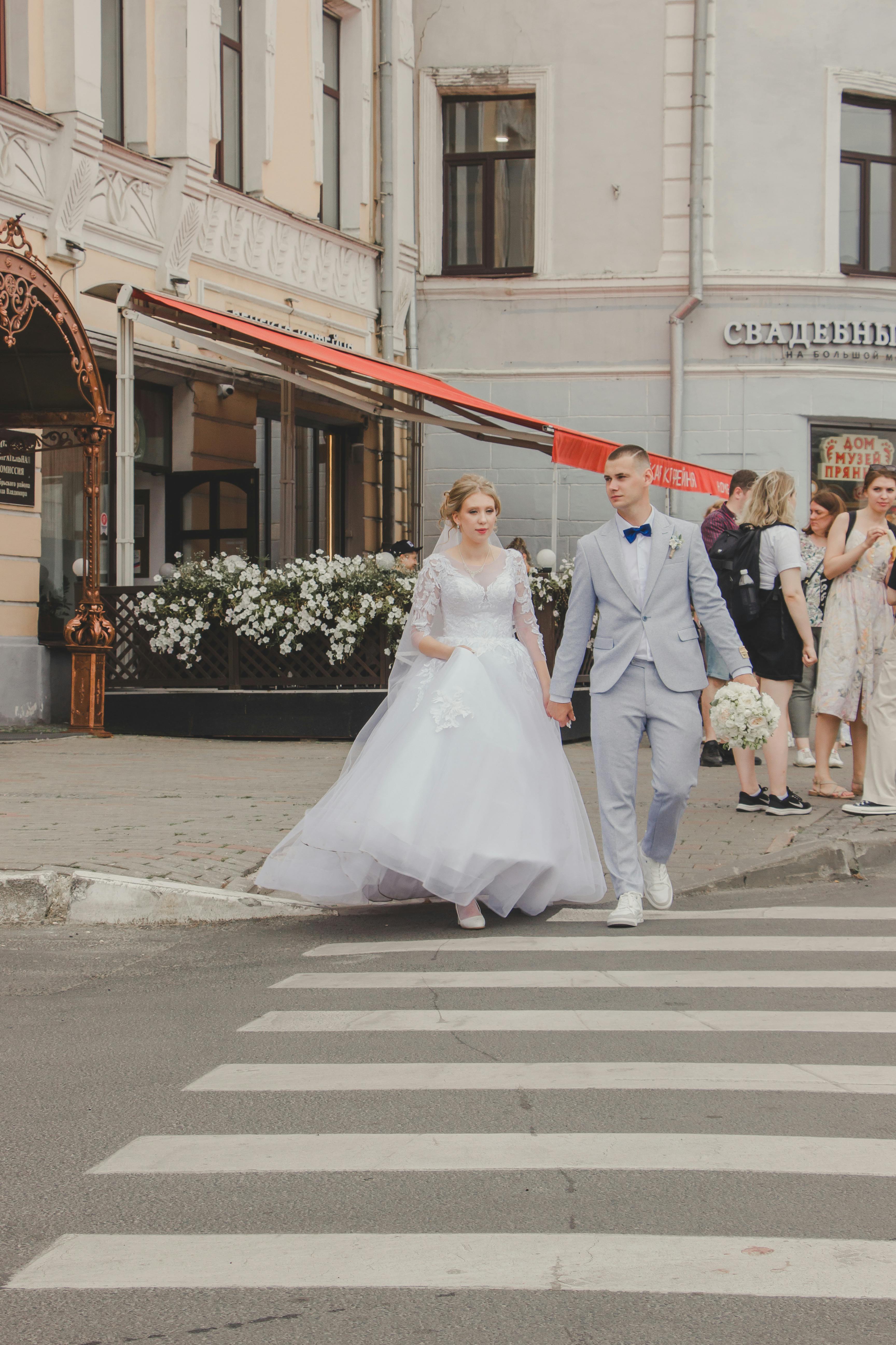Bride and Groom Crossing a Street · Free Stock Photo
