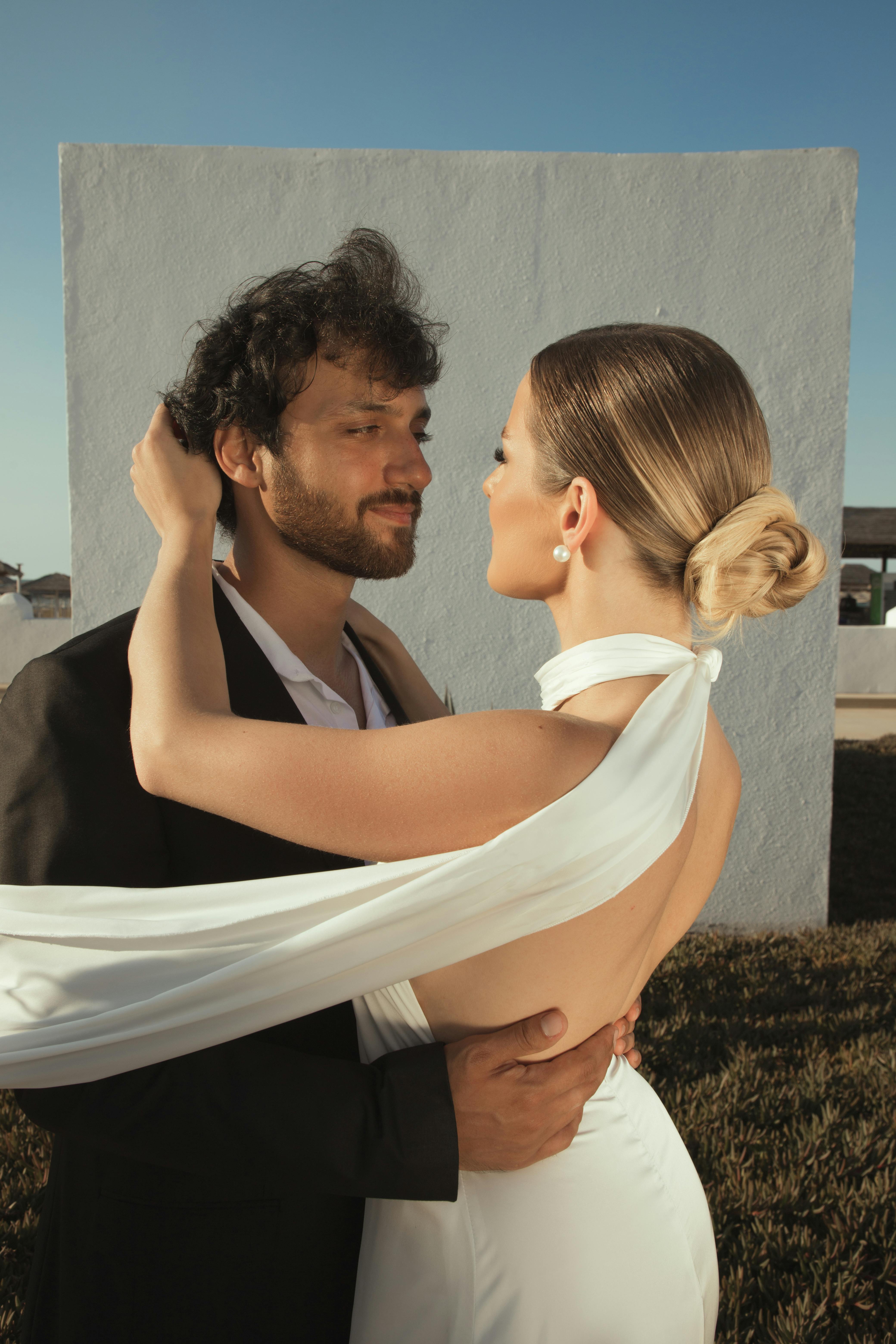 Bride Wearing a Traditional Dress and Hijab and Groom in a Tuxedo ...