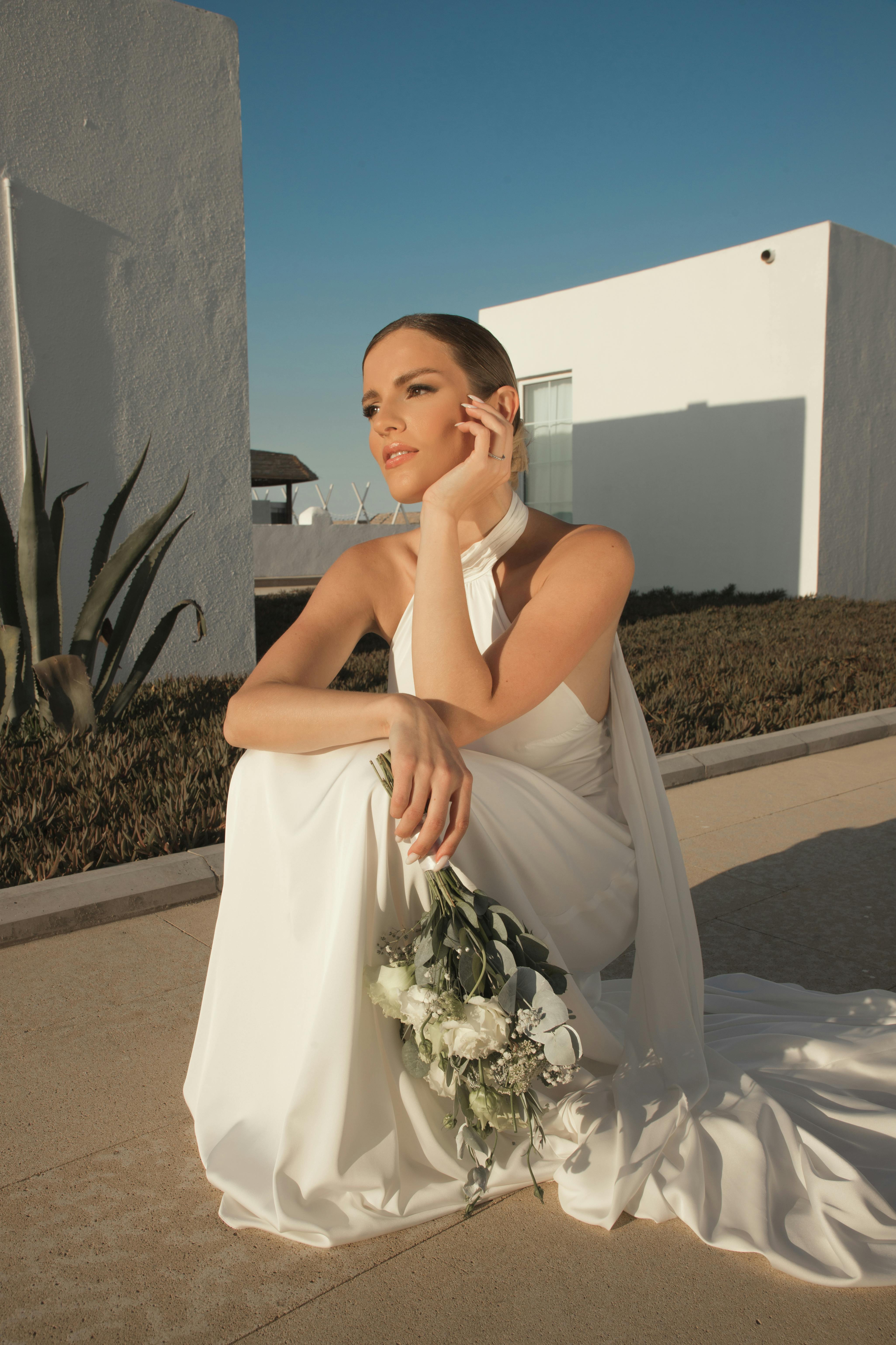 Bride Squatting with Flowers Bouquet · Free Stock Photo