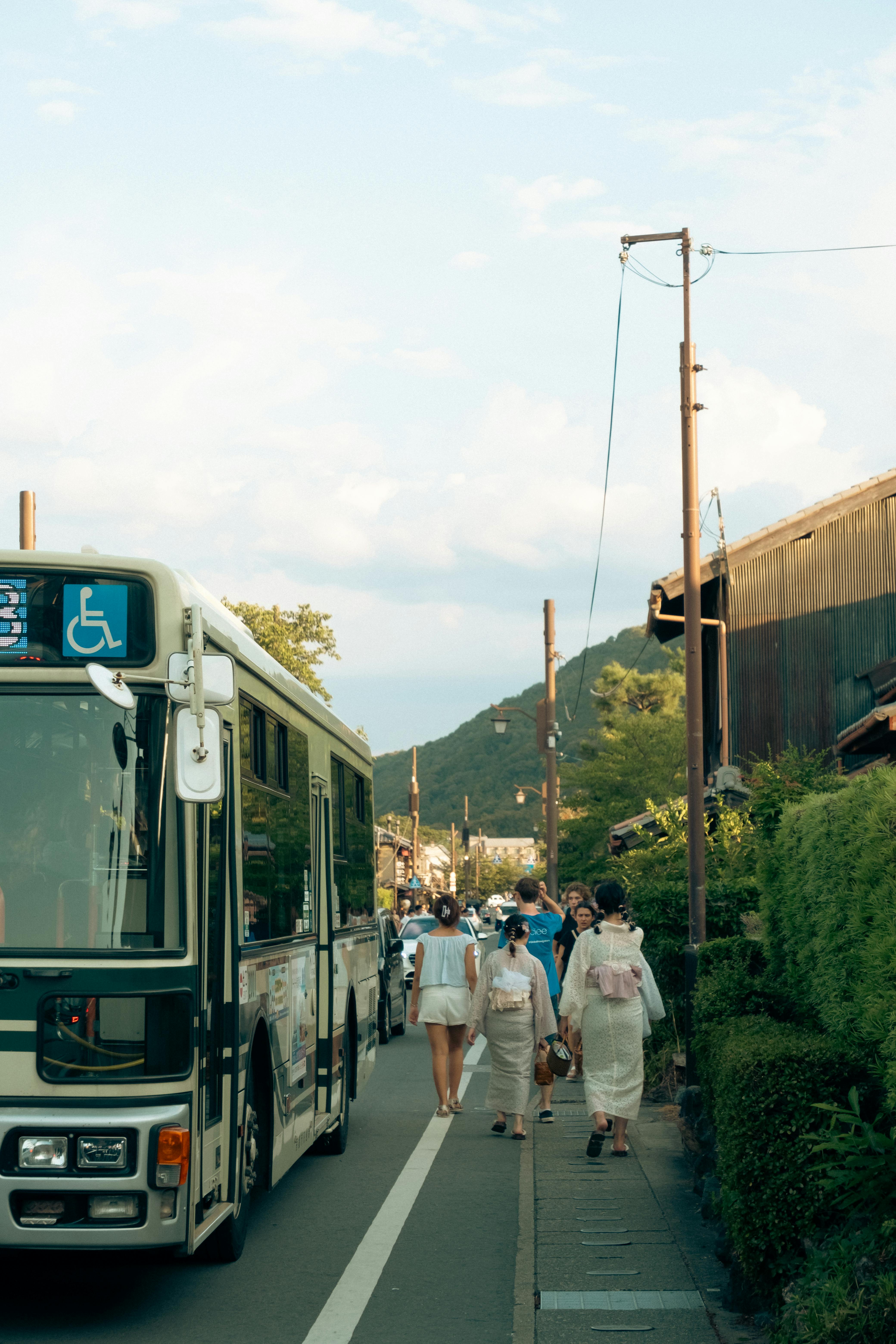 View of People Walking on a Sidewalk and Bus Driving on a Street · Free ...