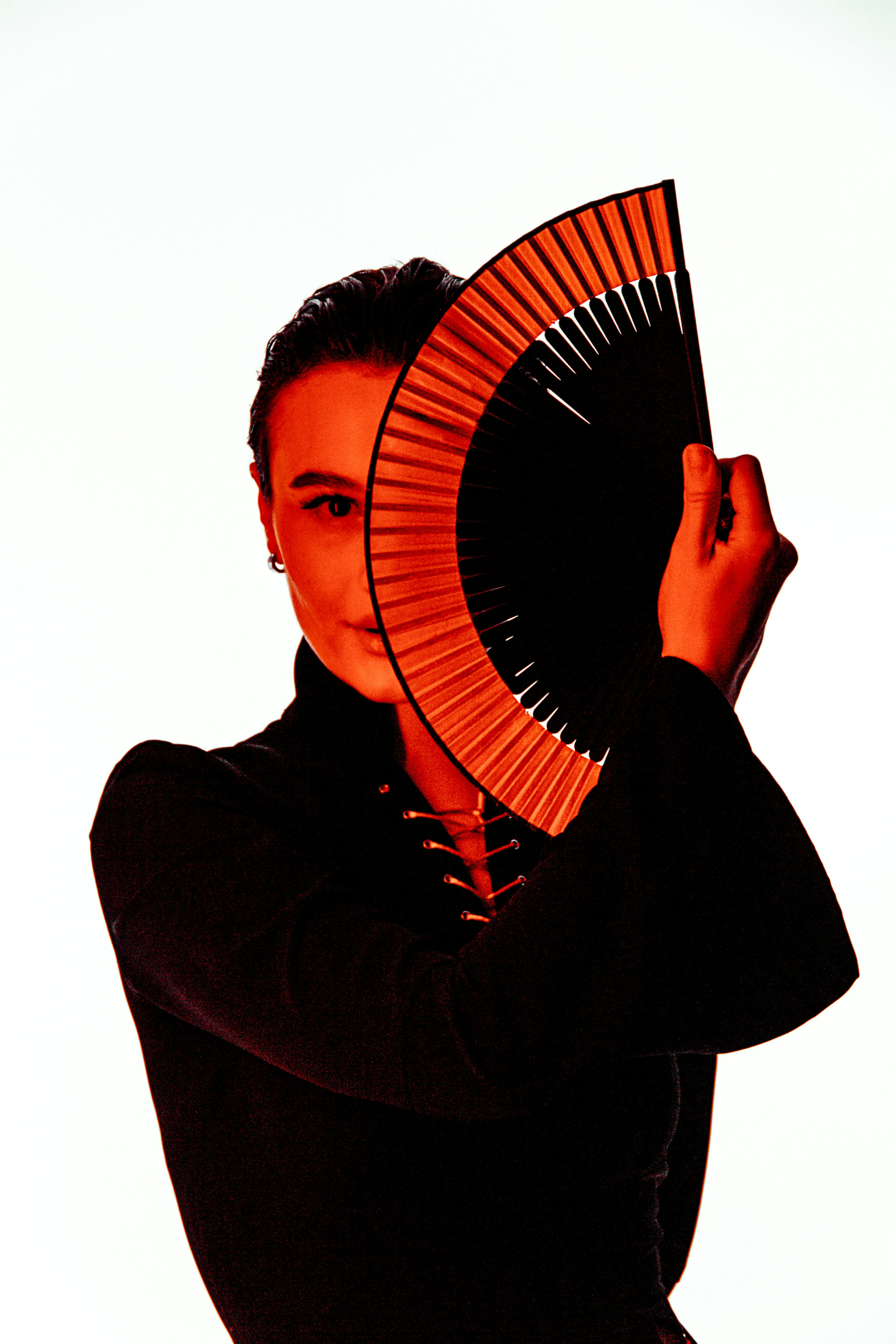 Woman with Hand Fan Posing on White Studio Background · Free Stock Photo