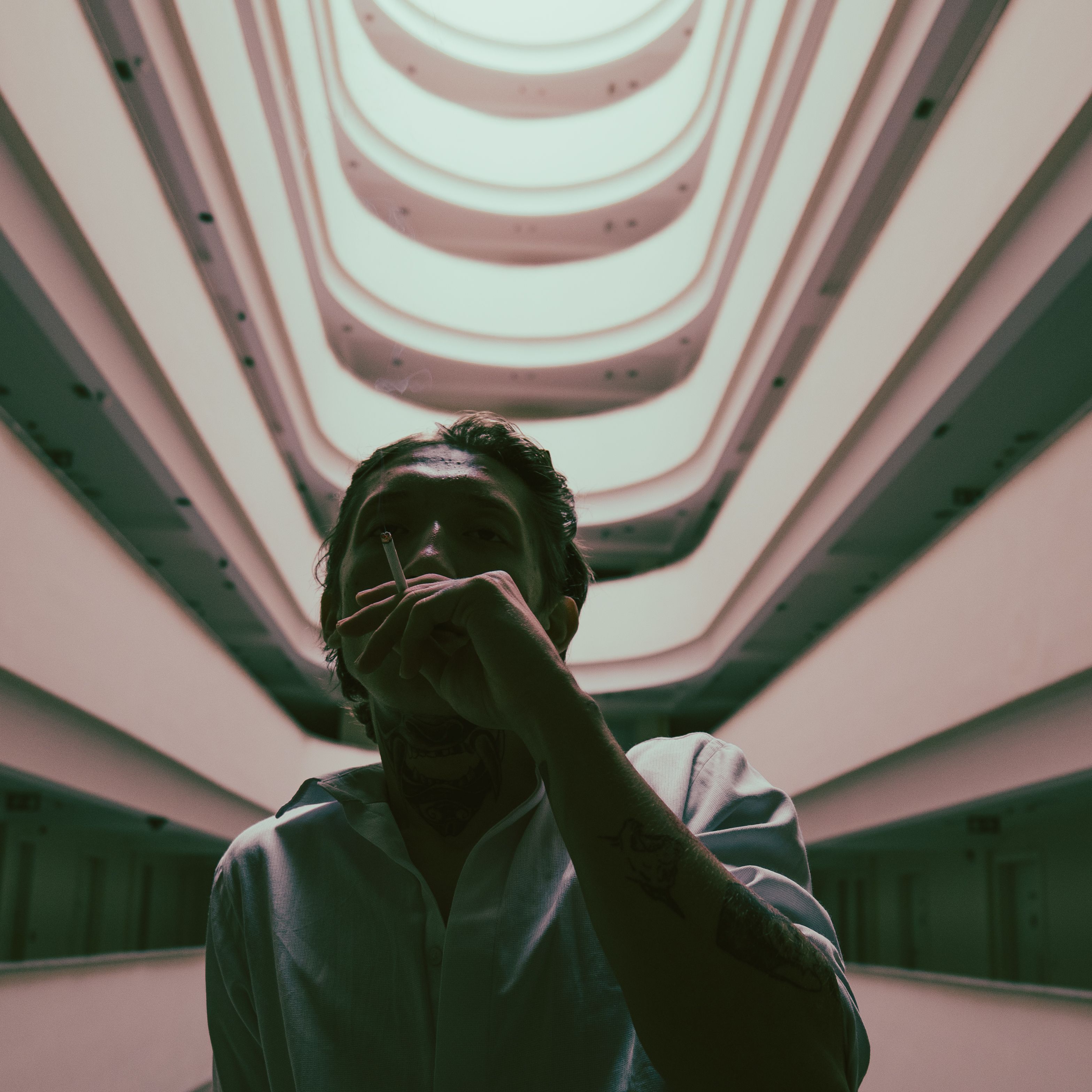 Man Smoking on Balcony · Free Stock Photo