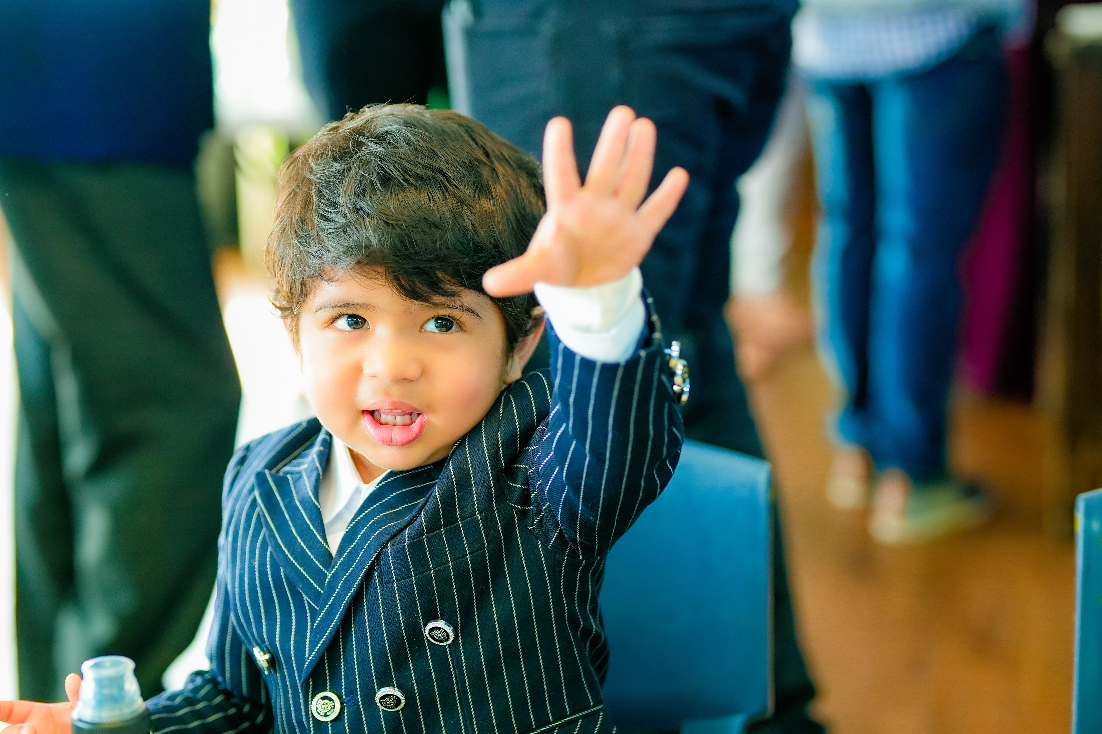 Cute Boy in Suit Sitting on Couch · Free Stock Photo