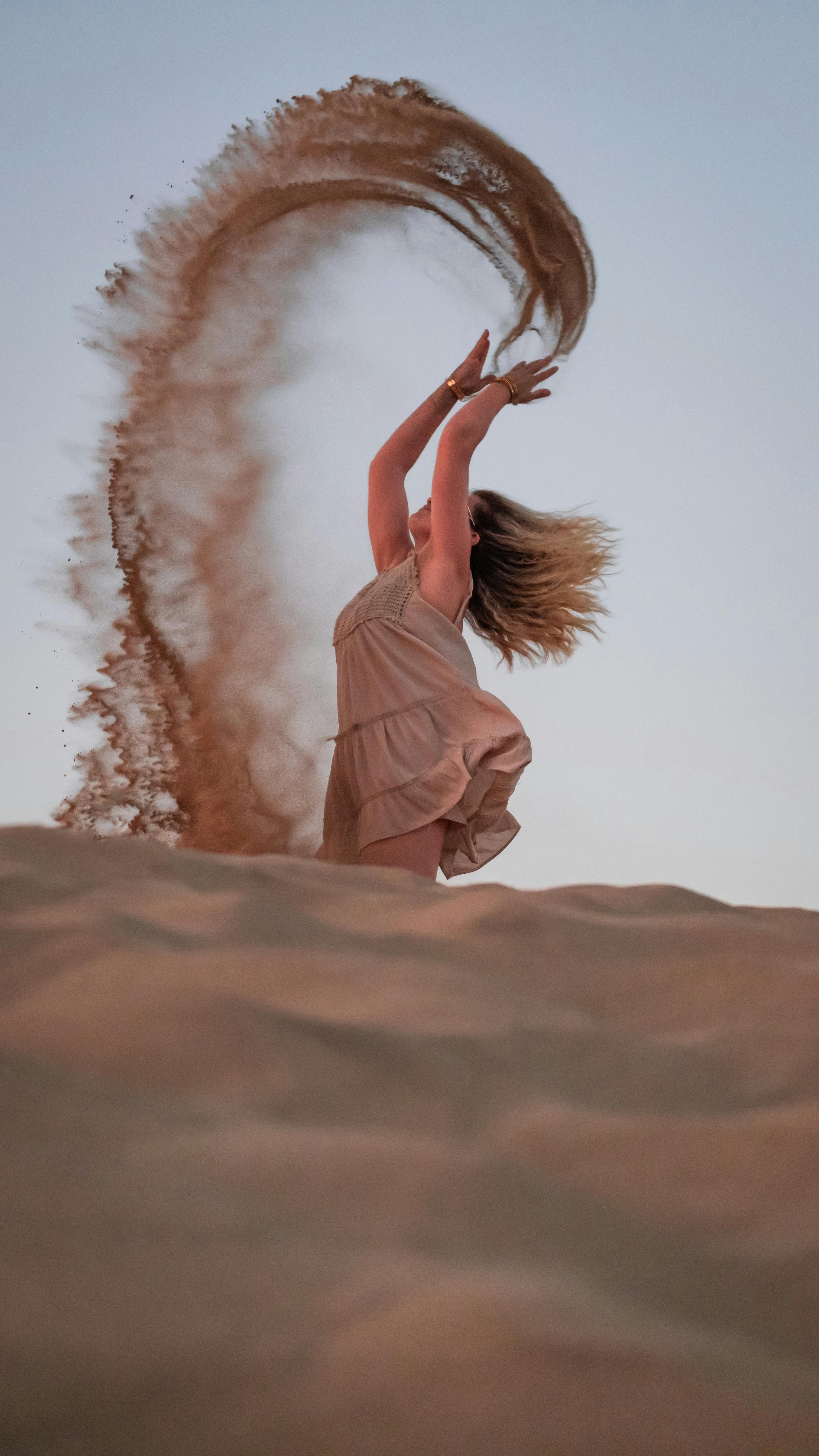 Woman Throwing Sand on the Beach · Free Stock Photo