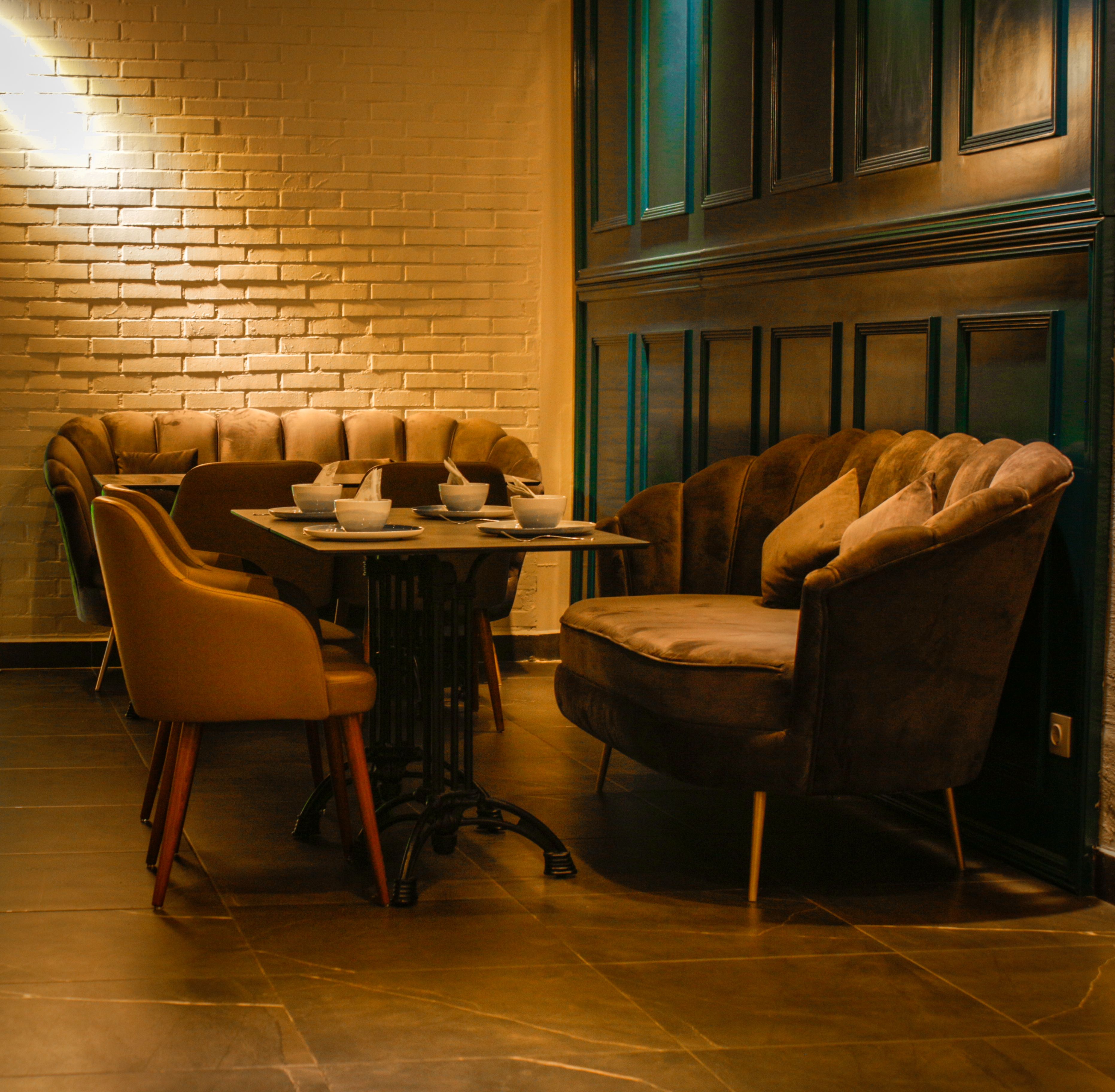 Interior of a Cafe with Sofas and · Free Stock Photo