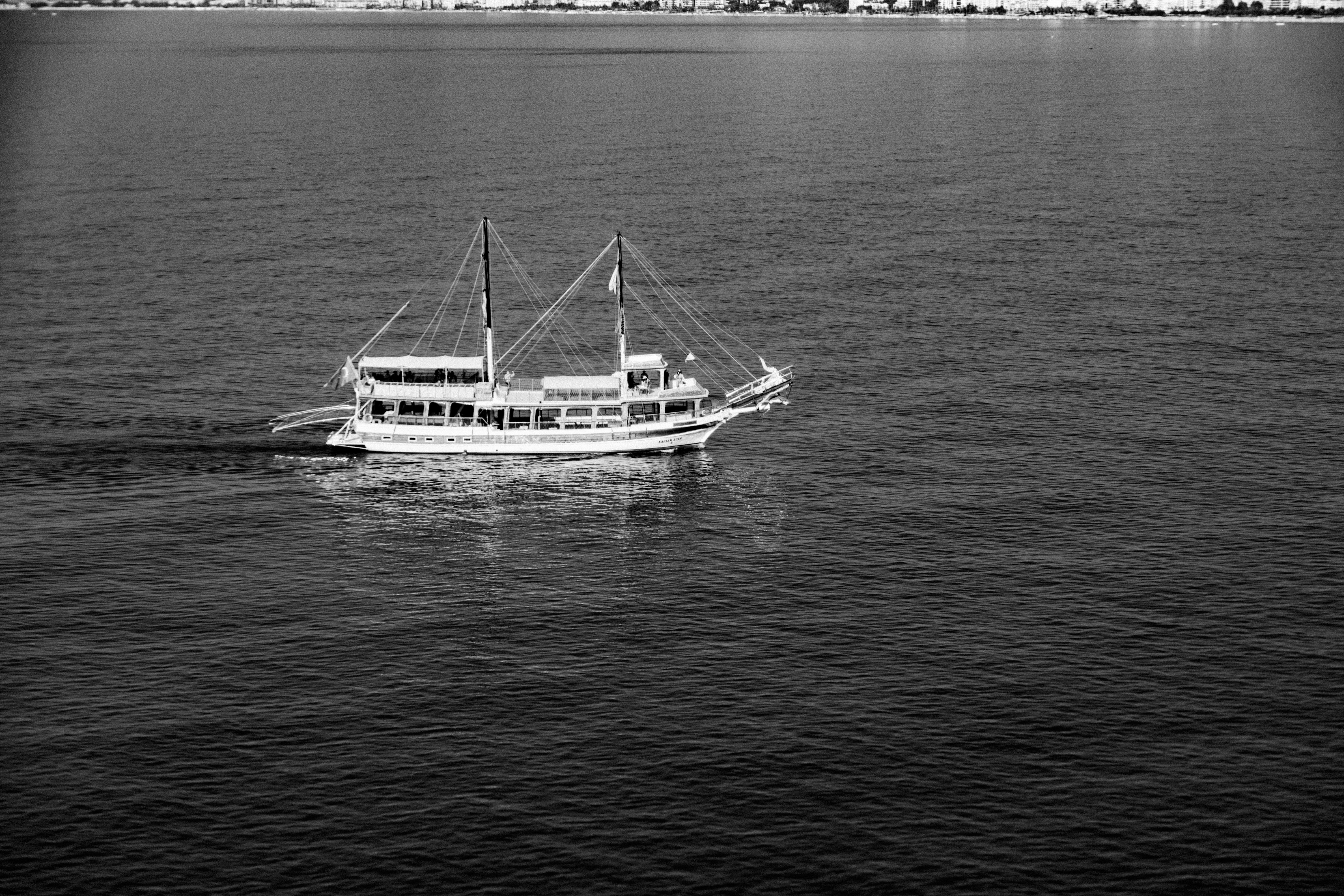 White Ship Traveling Through Vast Body of Water With White Birds Flying ...
