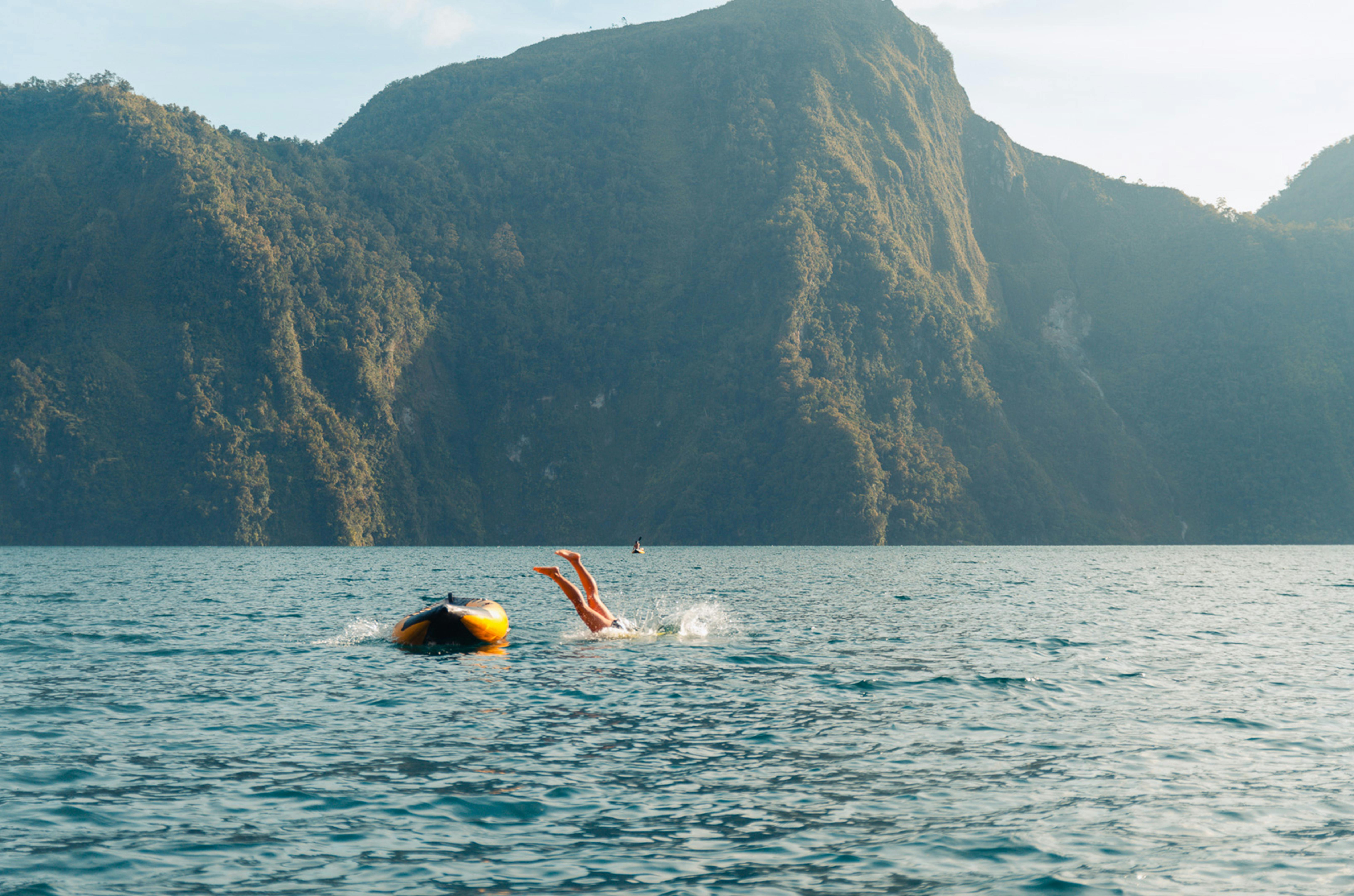 A Person Diving into the Water from a Little Boat · Free Stock Photo