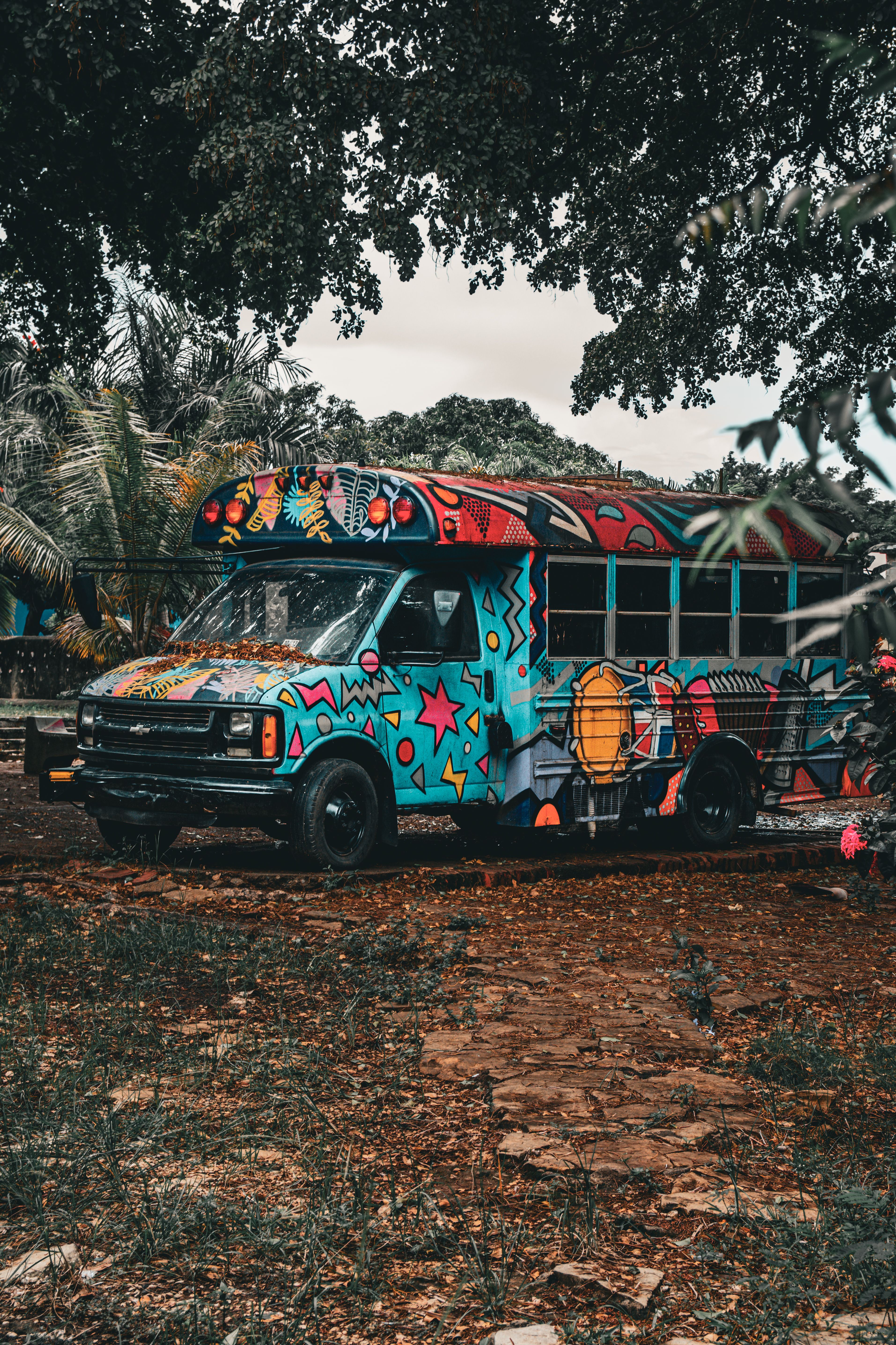 Colorful Camper Among Trees · Free Stock Photo