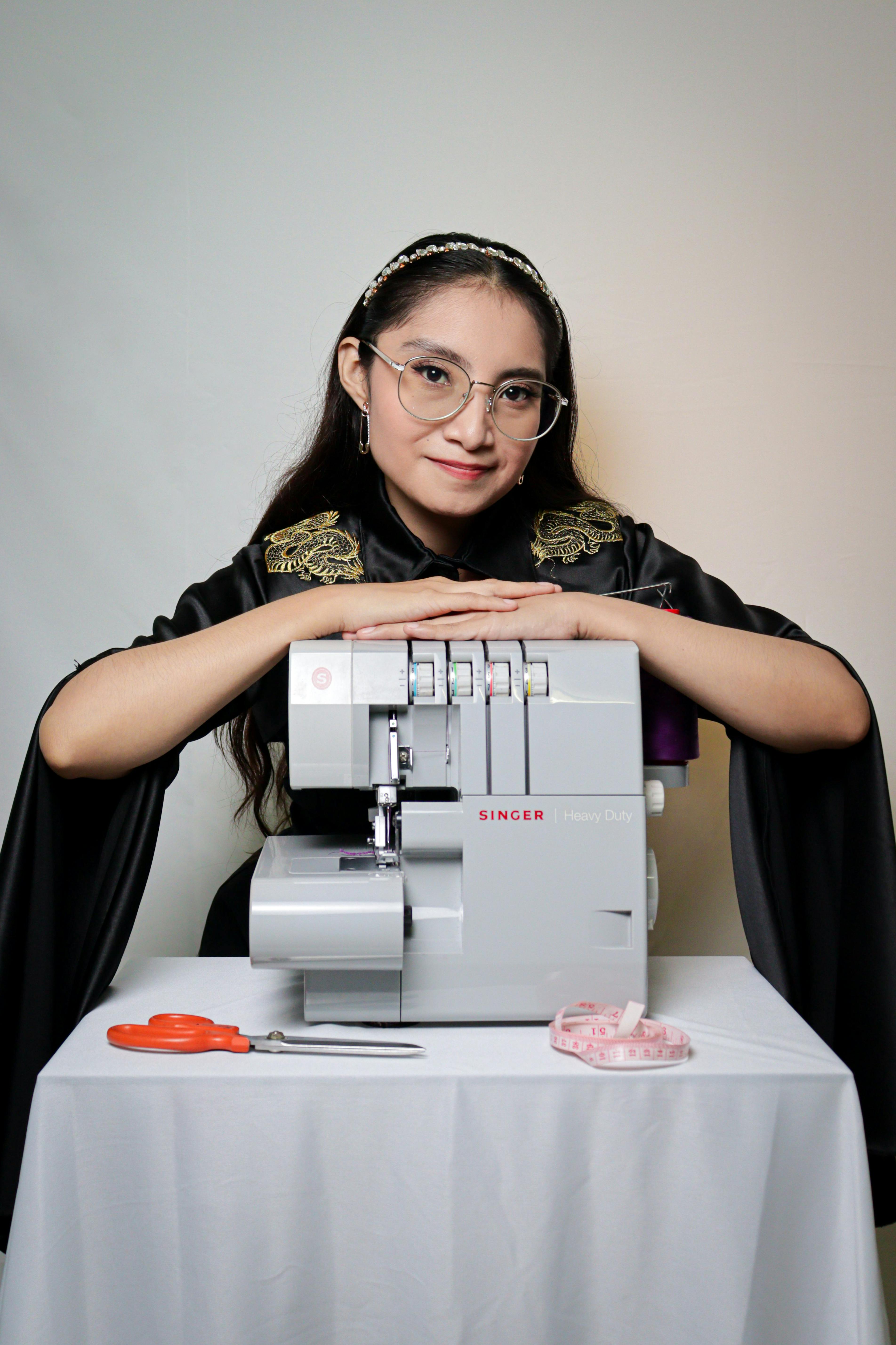 A Woman Using a Sewing Machine · Free Stock Photo