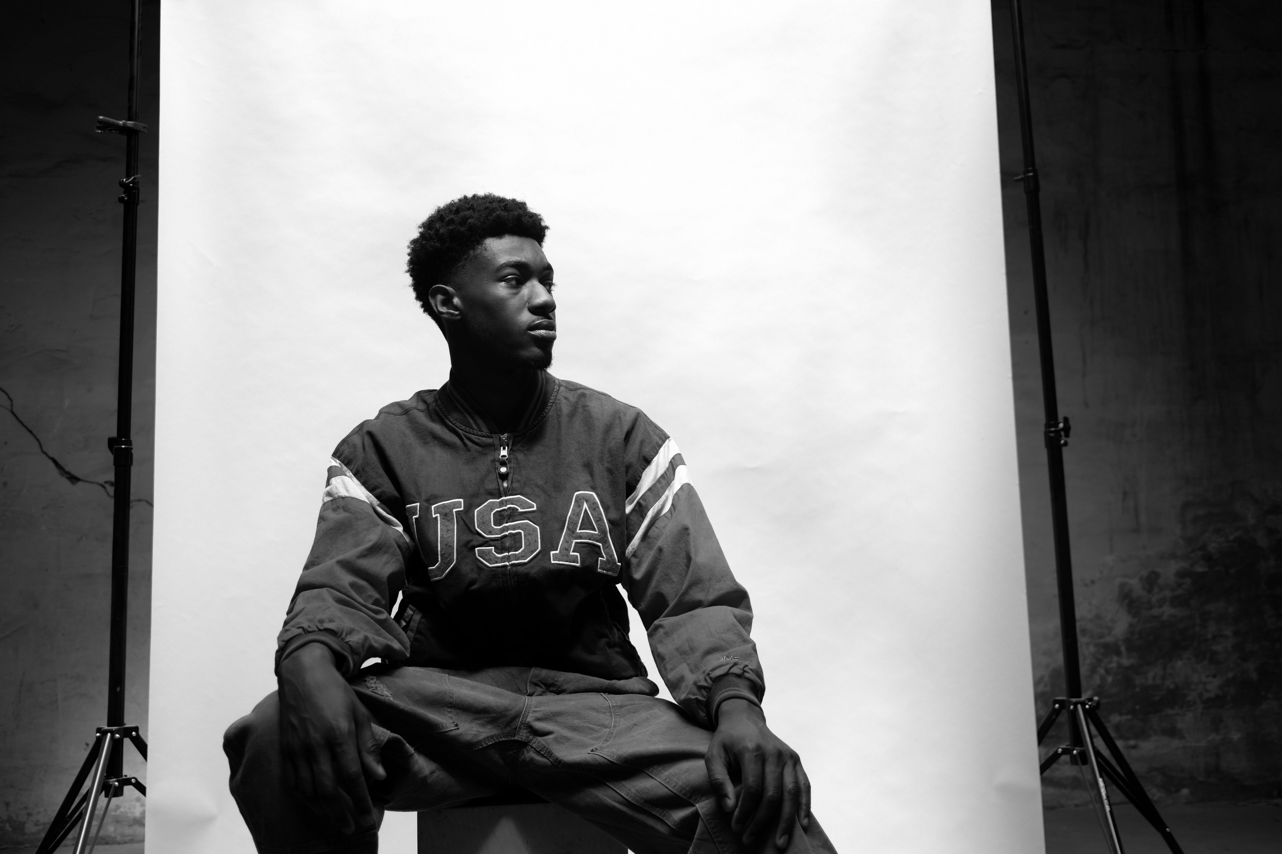 Man Sitting in Black and White · Free Stock Photo
