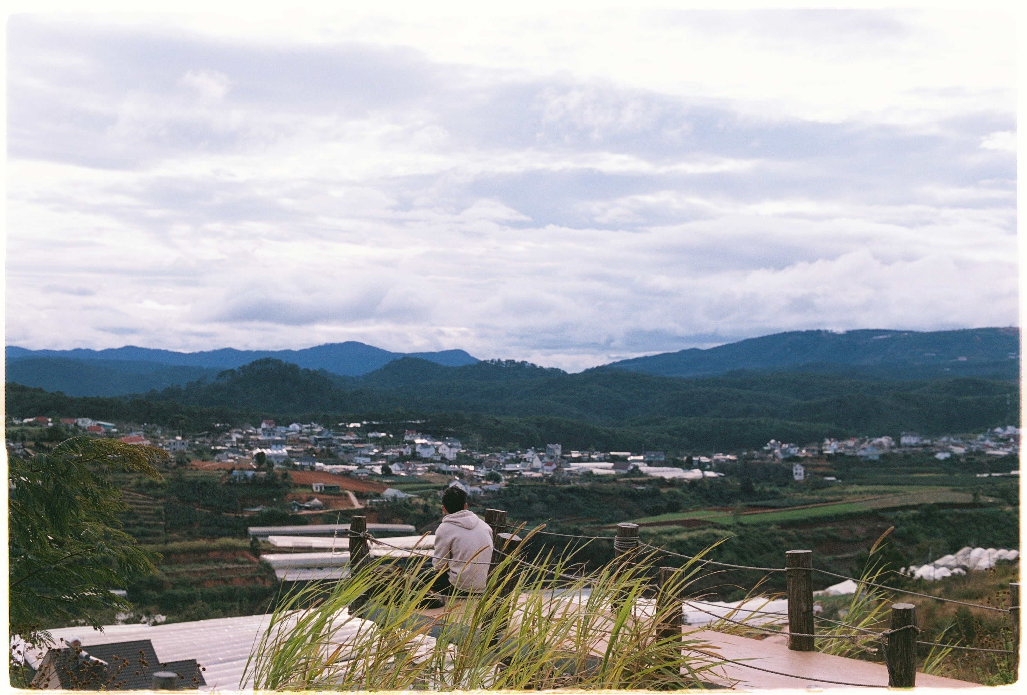A Person Sitting on a Lookout Point and Looking at the Town and ...