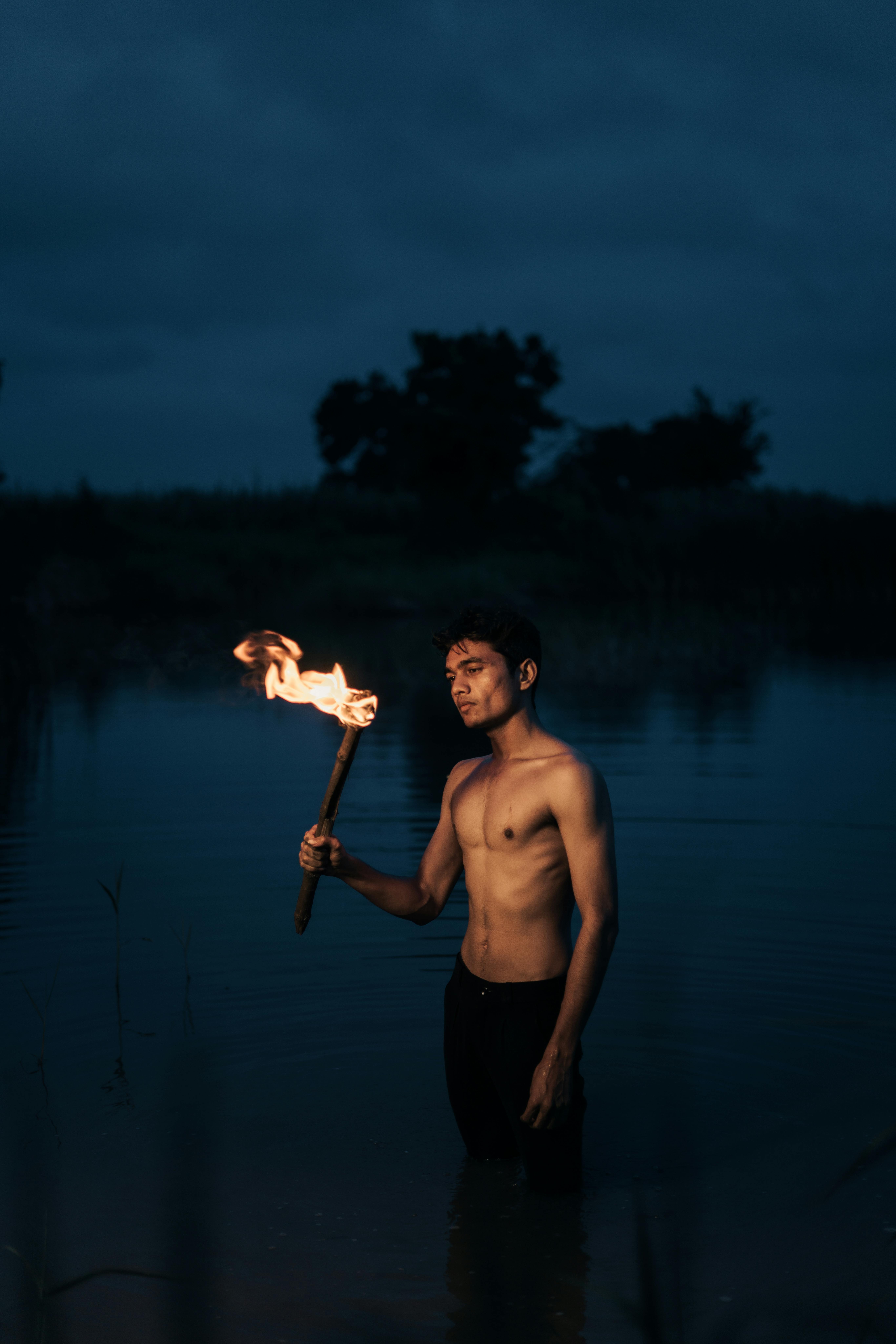Back View of Man with Torch at Night · Free Stock Photo