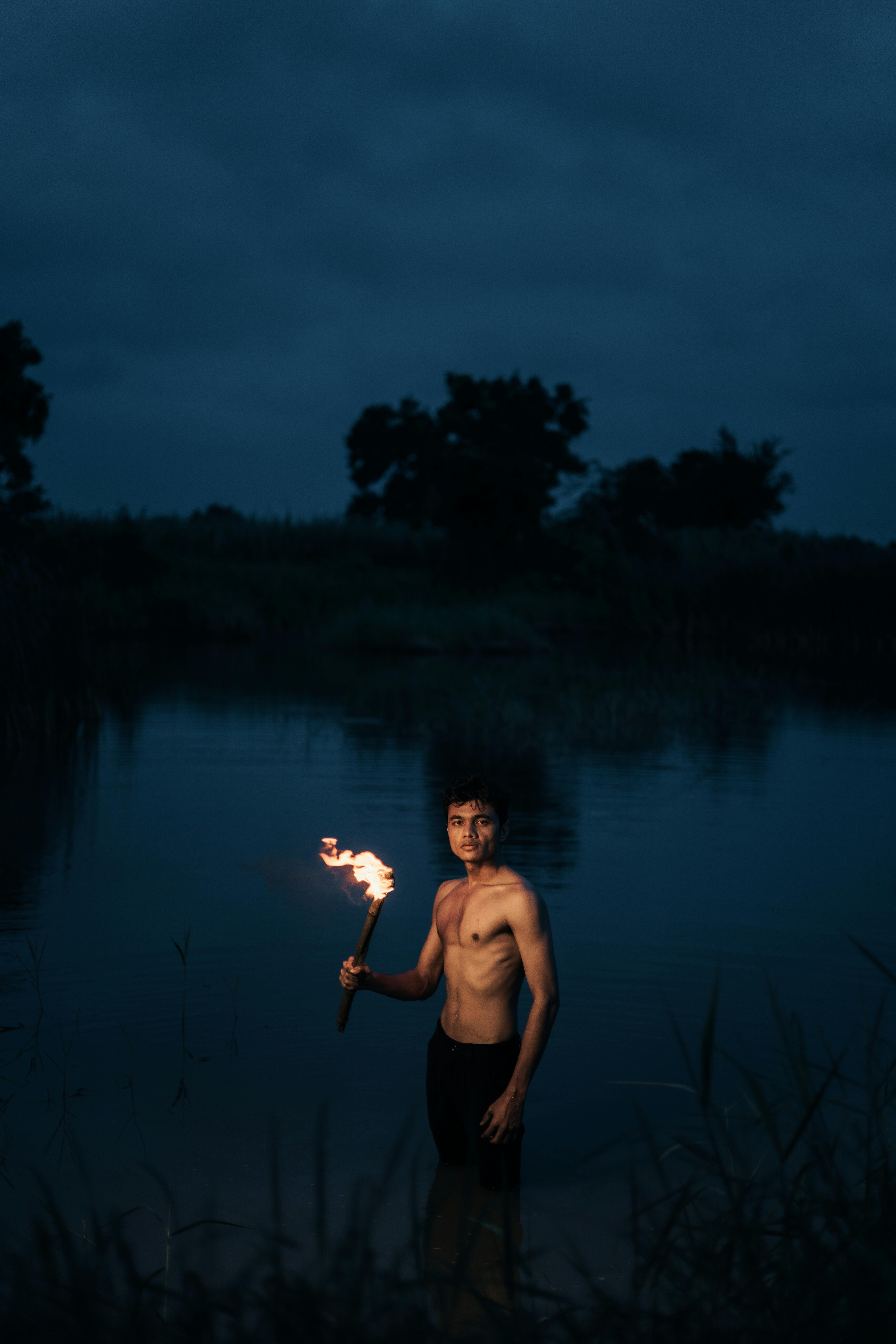 Man Standing With Torch Photos, Download The BEST Free Man Standing ...