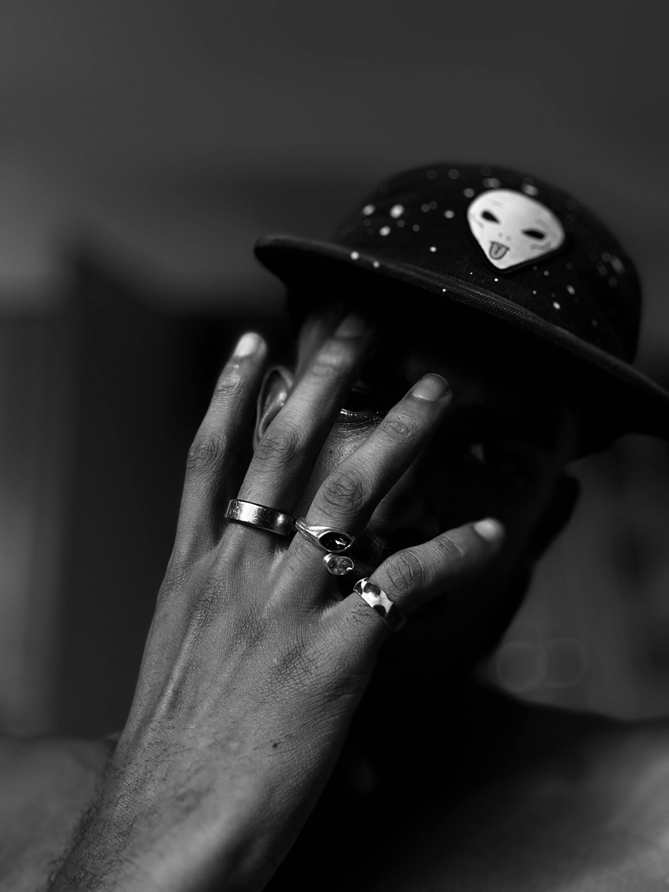 Close-Up Photo of a Man Covering His Face with His Hand with Rings ...