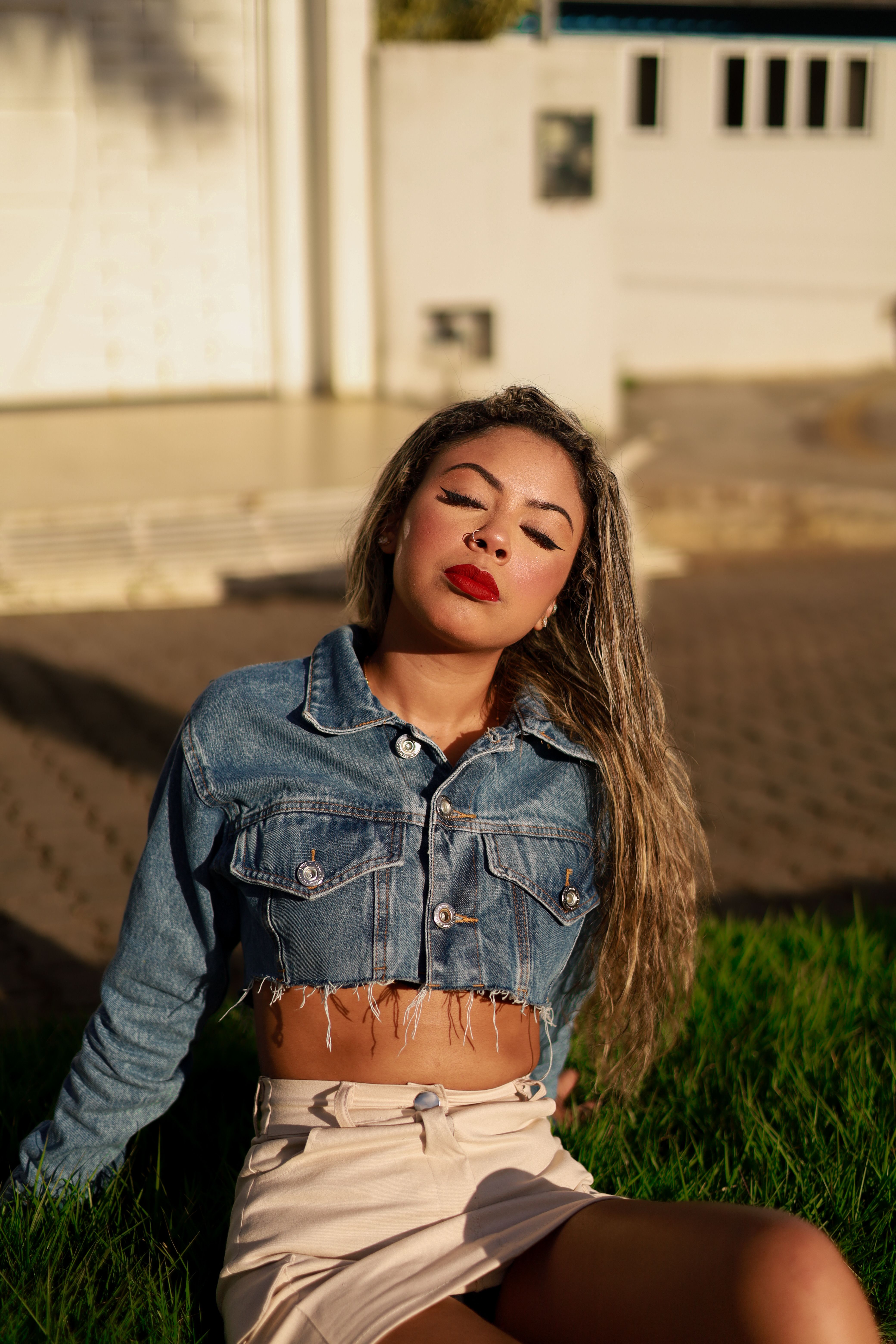 Young Woman Sitting on the Ground Outside in Sunlight · Free Stock Photo
