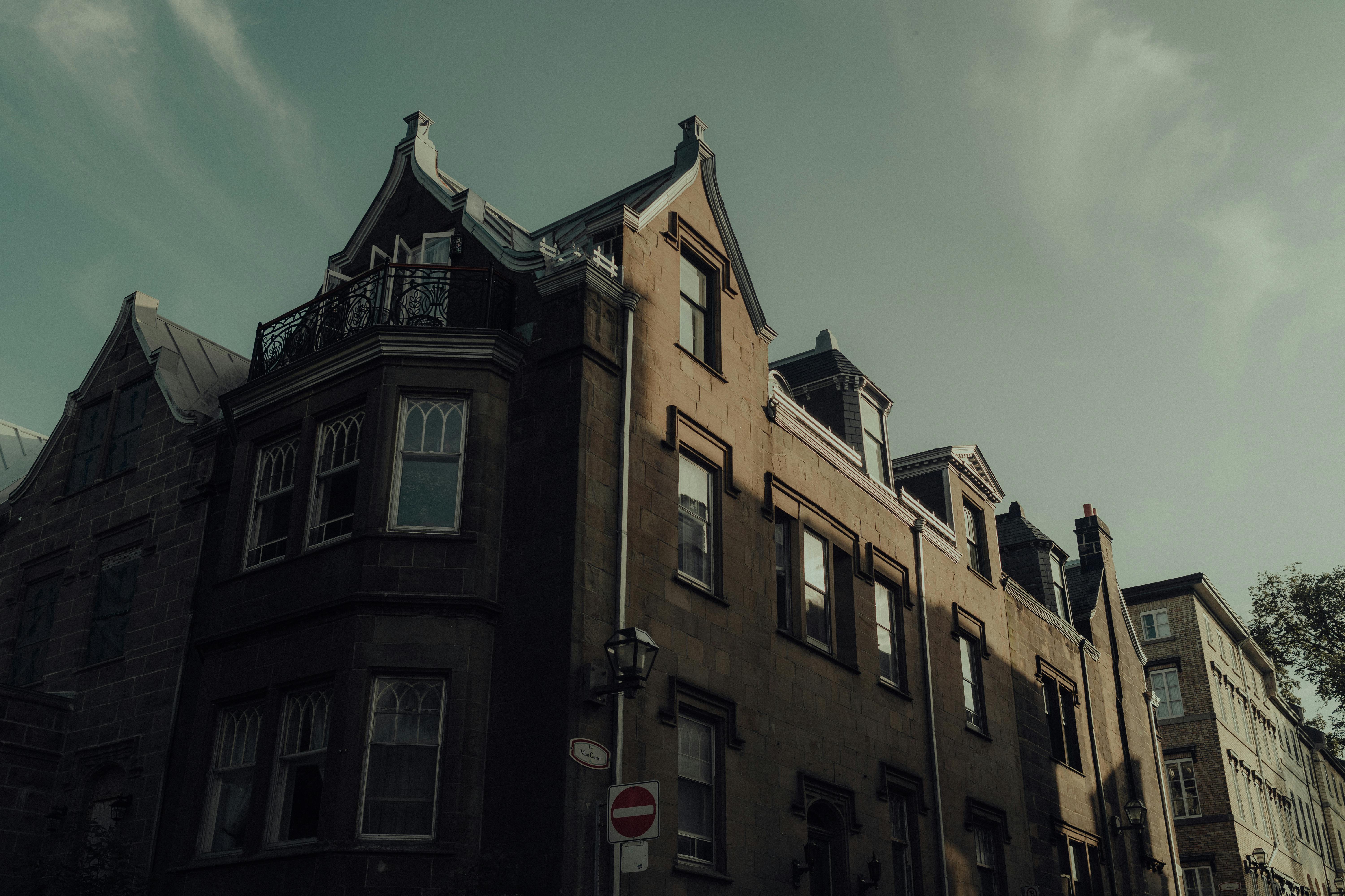 A photo of a building with a street sign · Free Stock Photo
