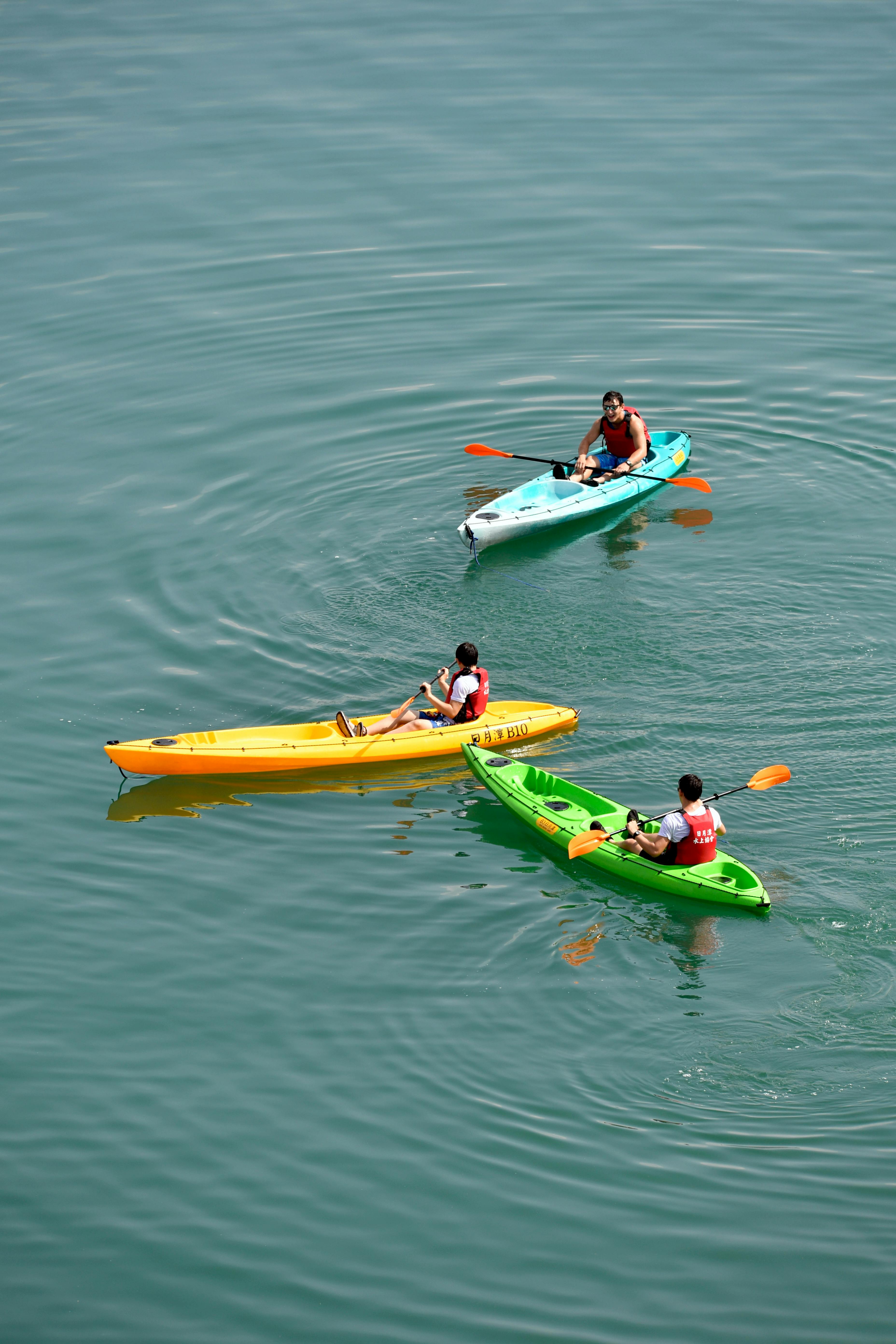 Tree Colored Kayaks on Water · Free Stock Photo