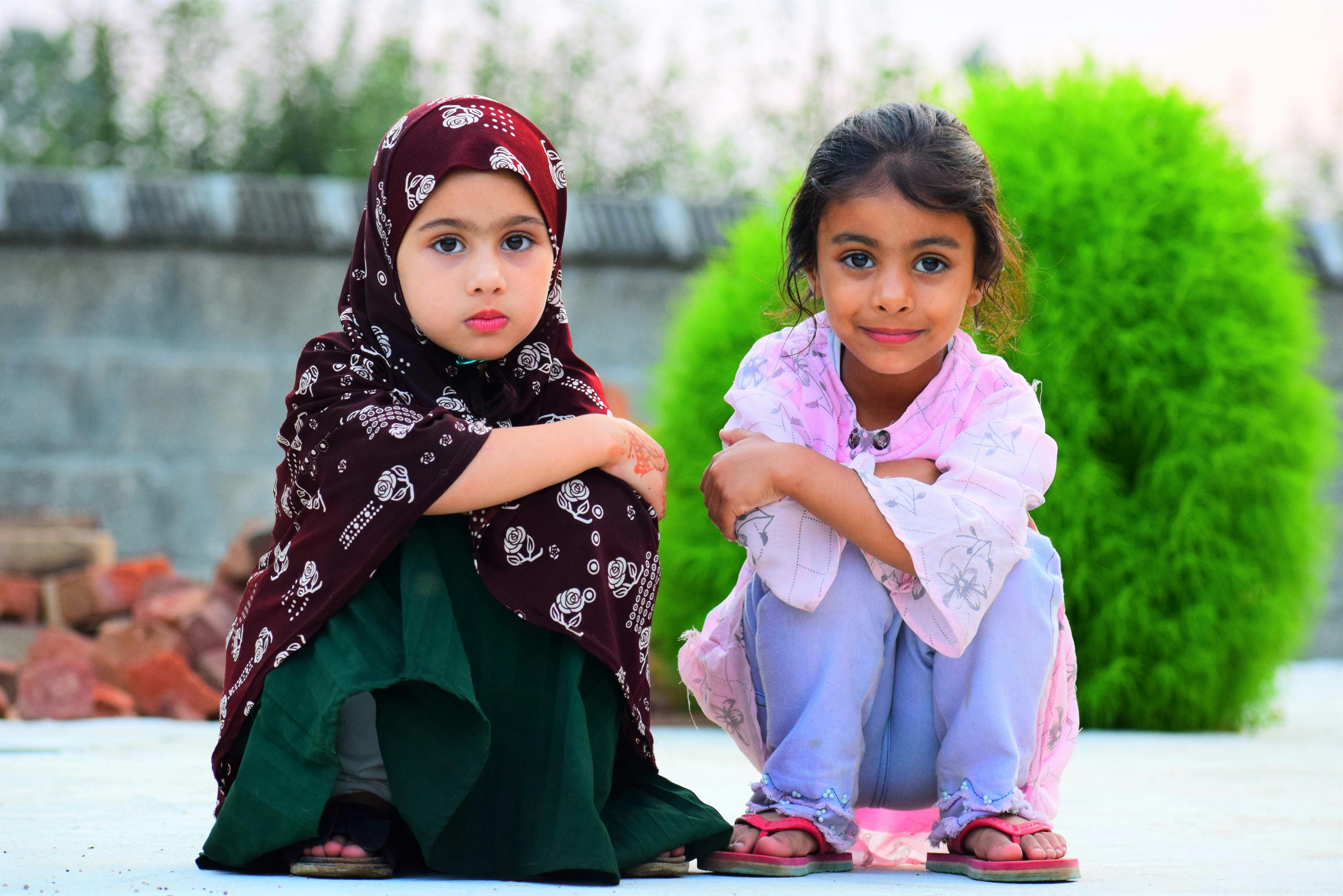 Two Young Girls of Different Cultures Sitting Together · Free Stock Photo