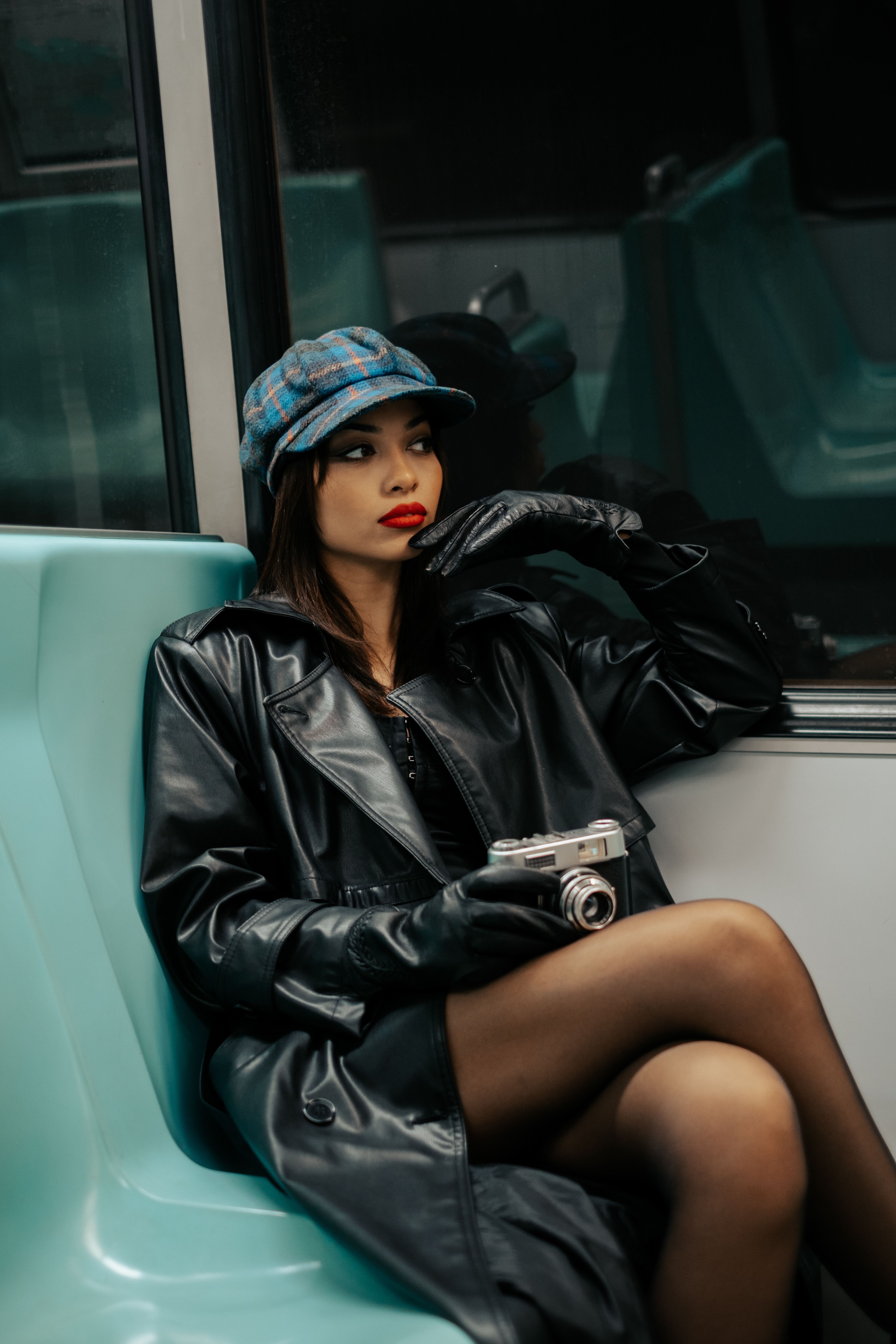 Brunette Woman in Leather Coat Sitting with Camera in Hand · Free Stock ...