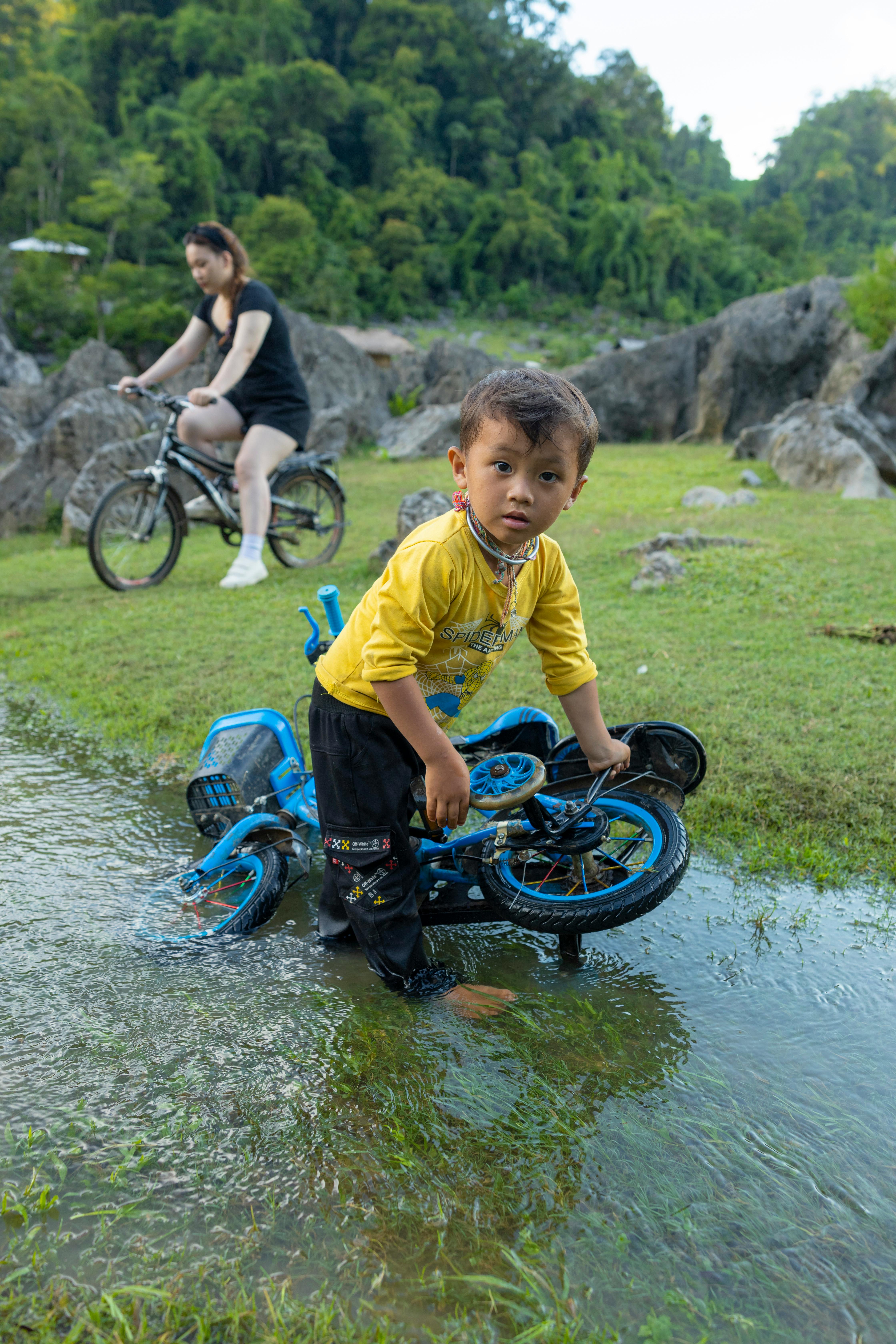 Boy Washing Bicycle in River · Free Stock Photo