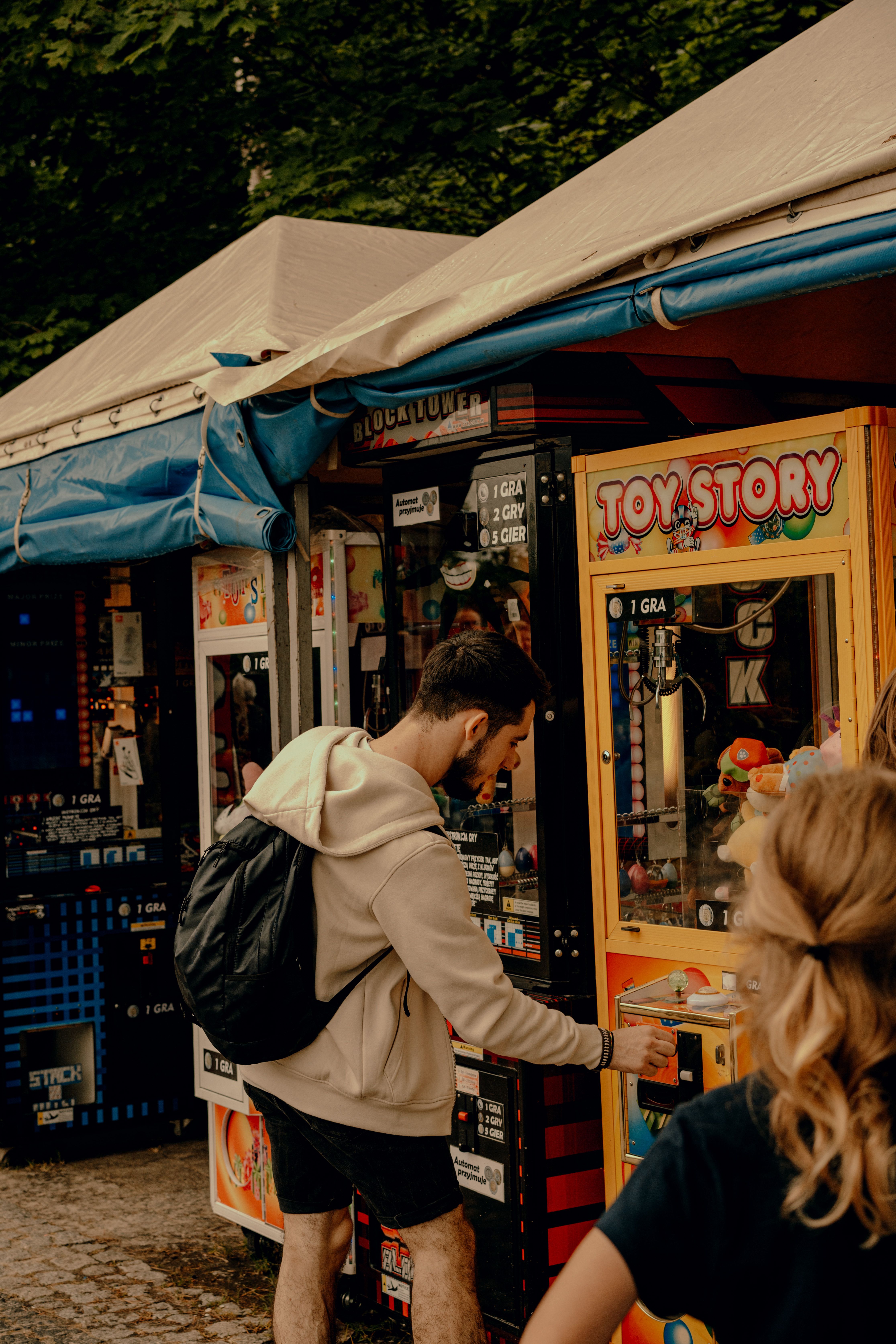 A Man Playing a Claw Machine · Free Stock Photo
