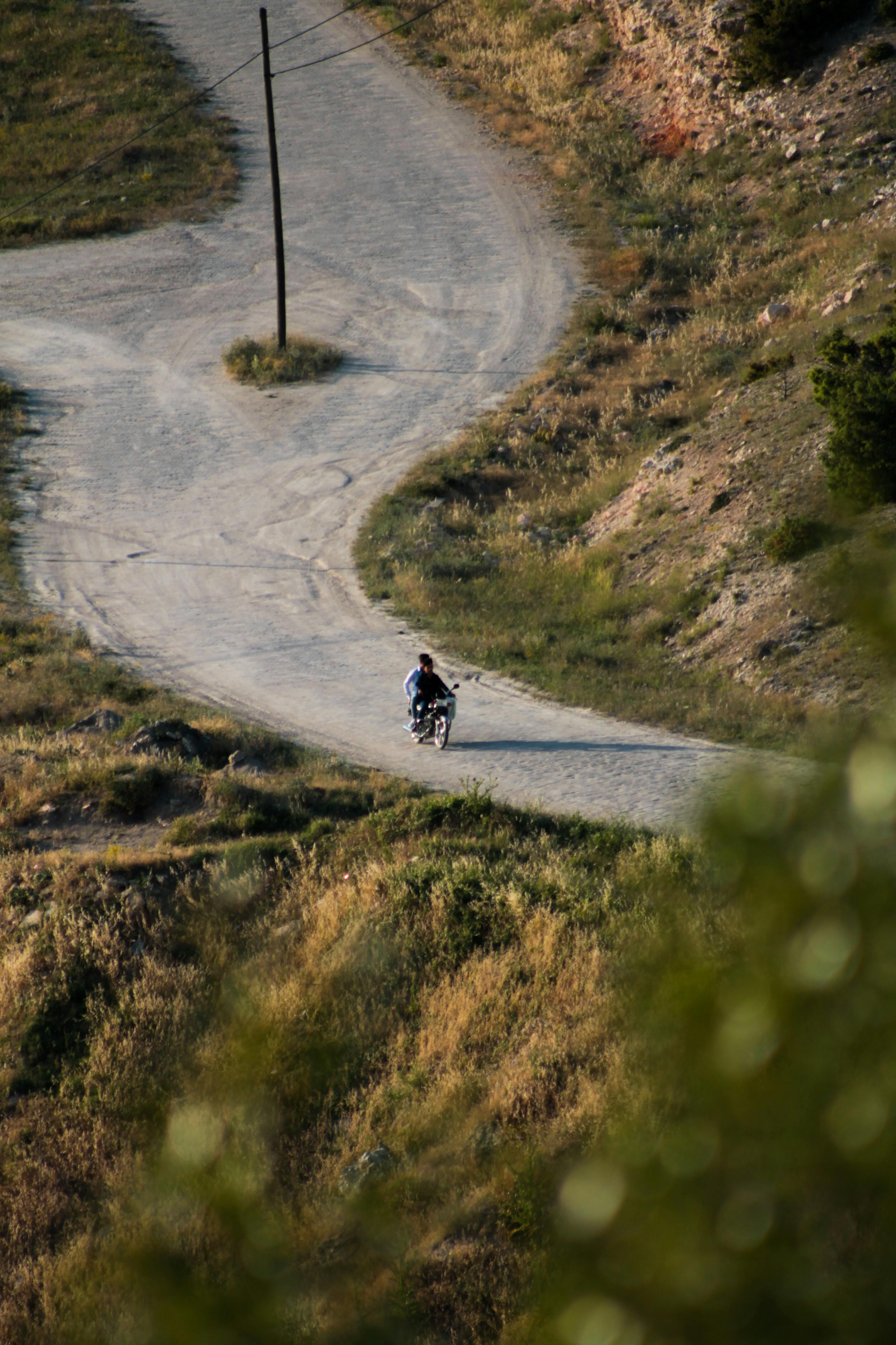 People Riding Bike on Road in Countryside · Free Stock Photo