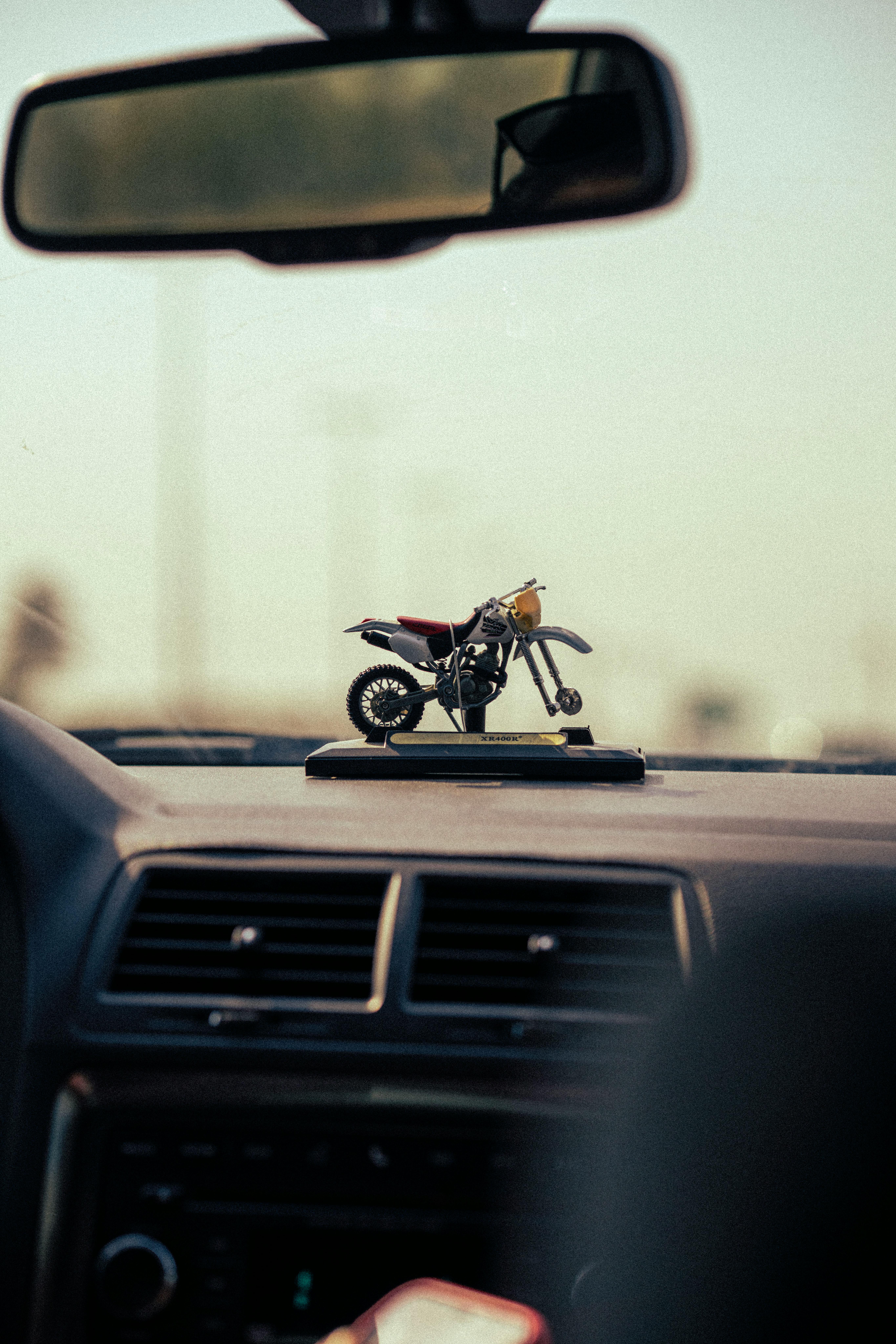 Motorcycle Figure on Car Dashboard · Free Stock Photo