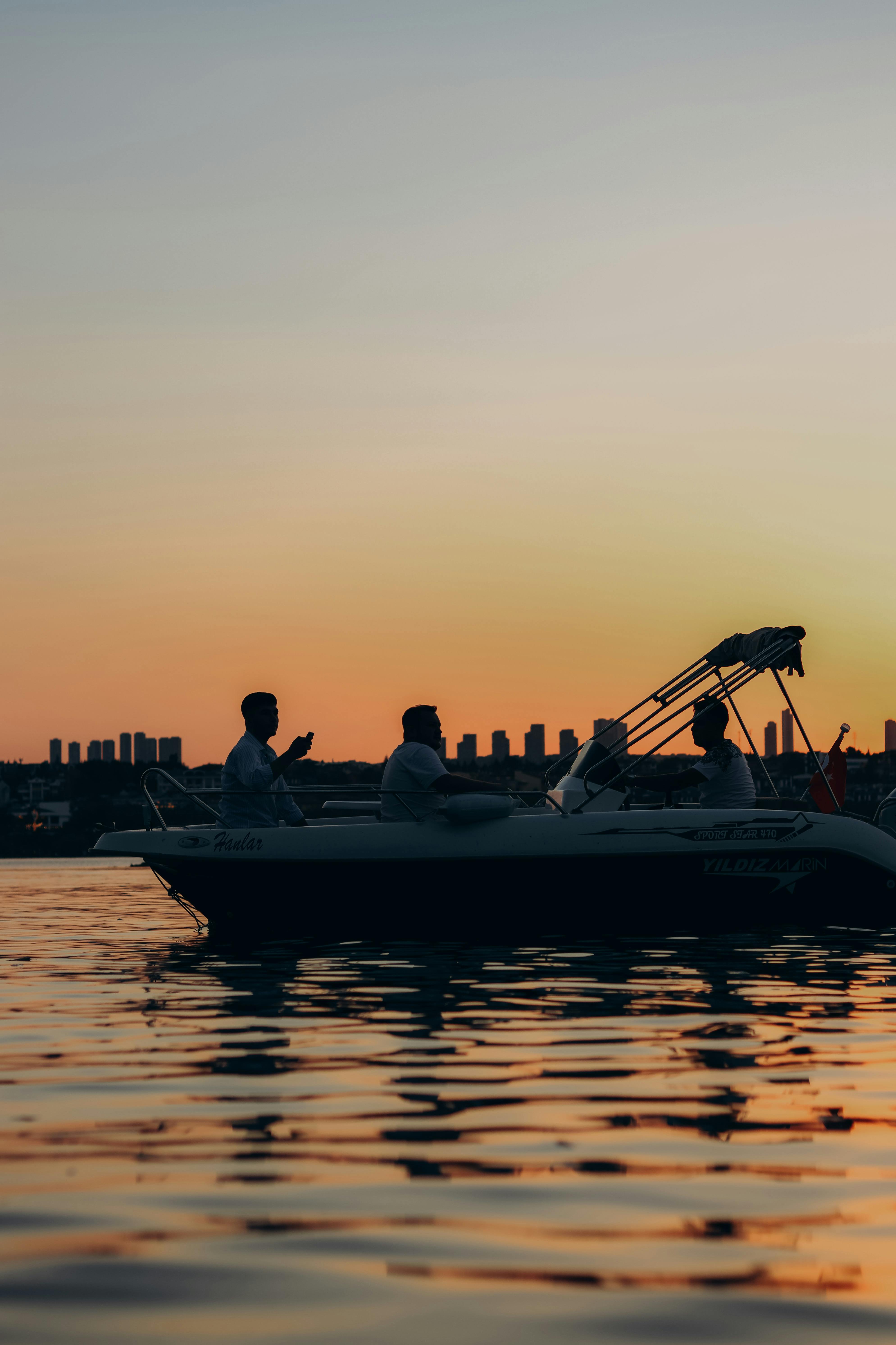 People on Motorboat at Sunset · Free Stock Photo