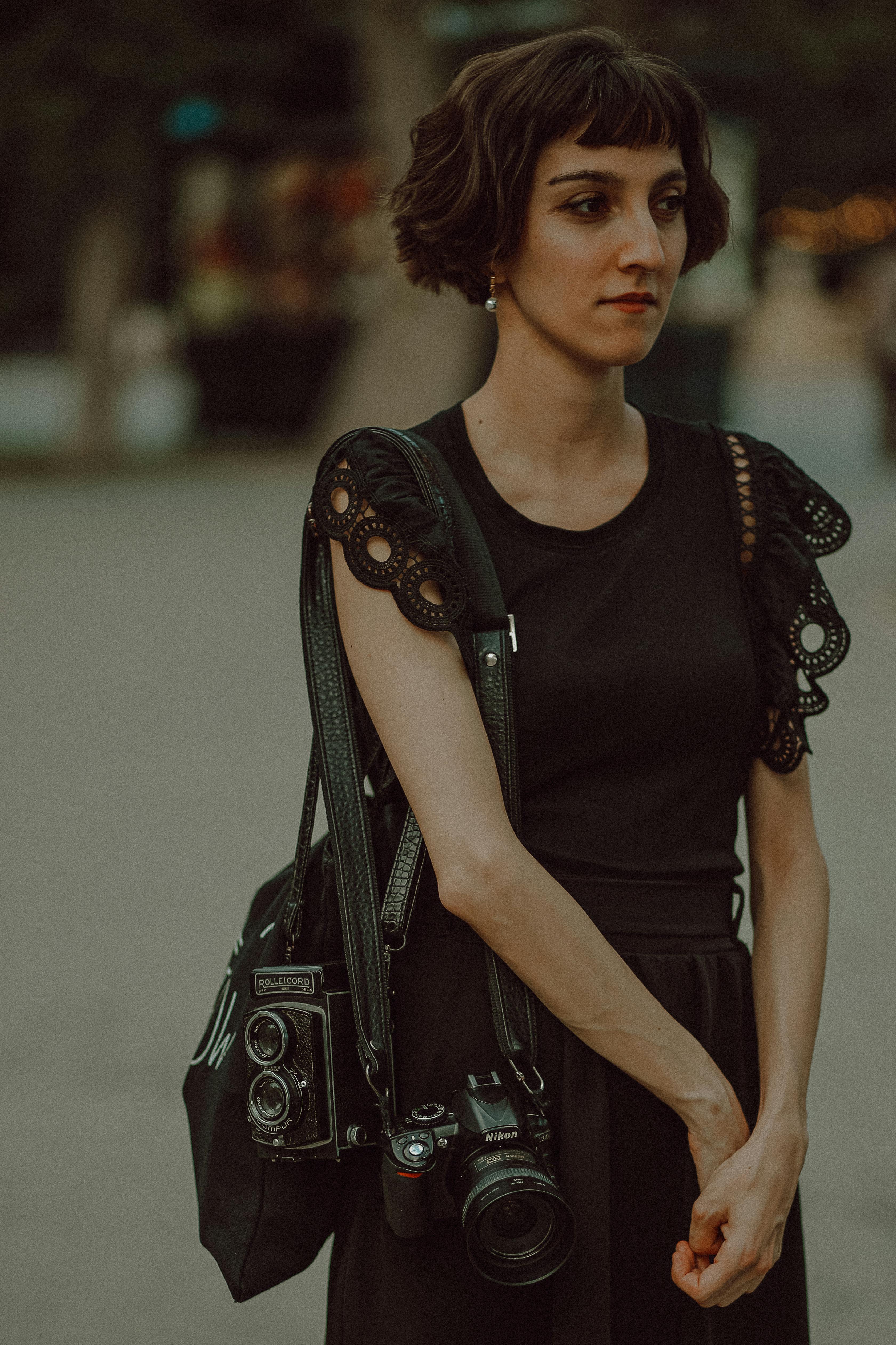 Young Woman with Cameras Hanging on Her Shoulder · Free Stock Photo