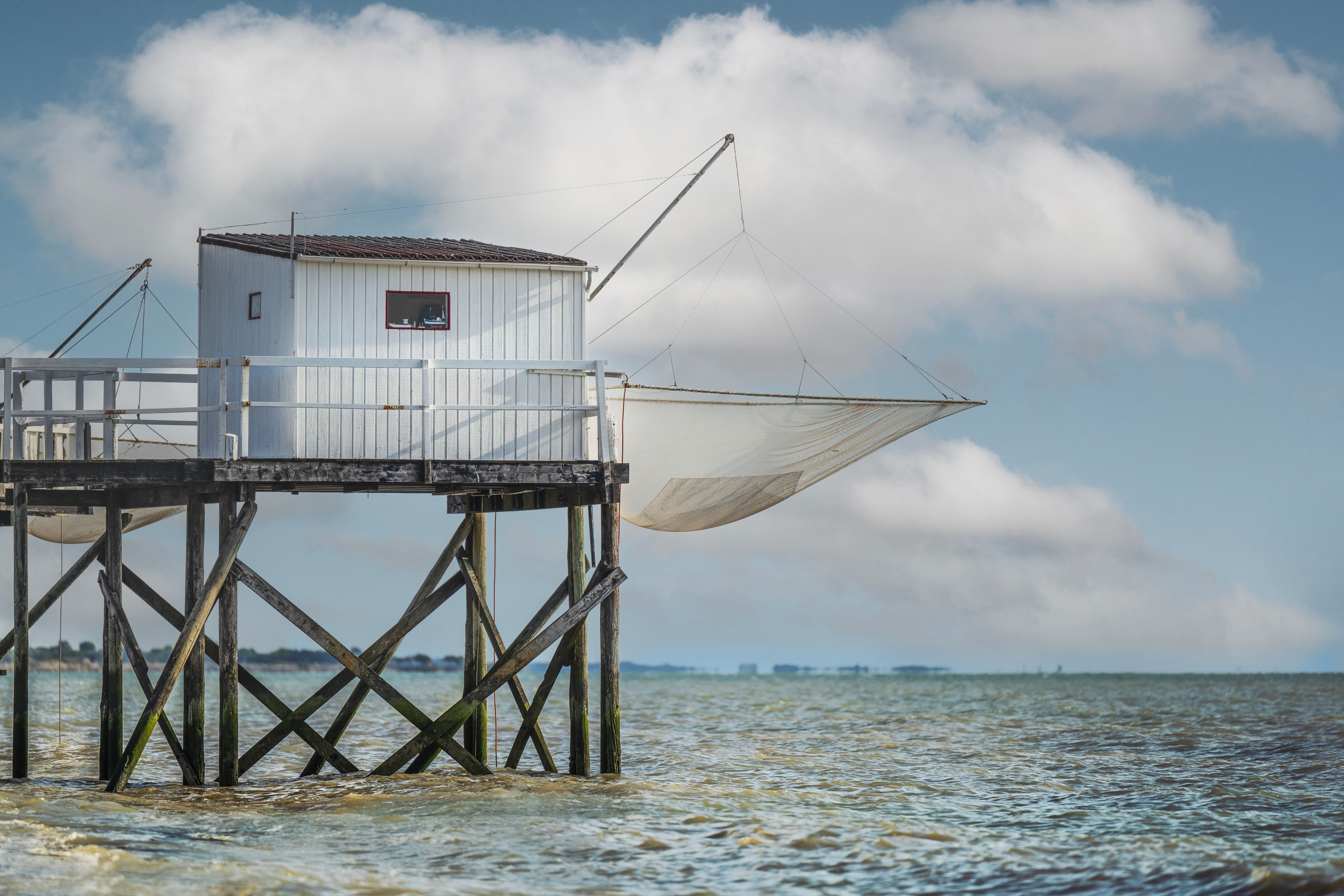 A Hut on Stilts with a Fishing Net on the Shore · Free Stock Photo