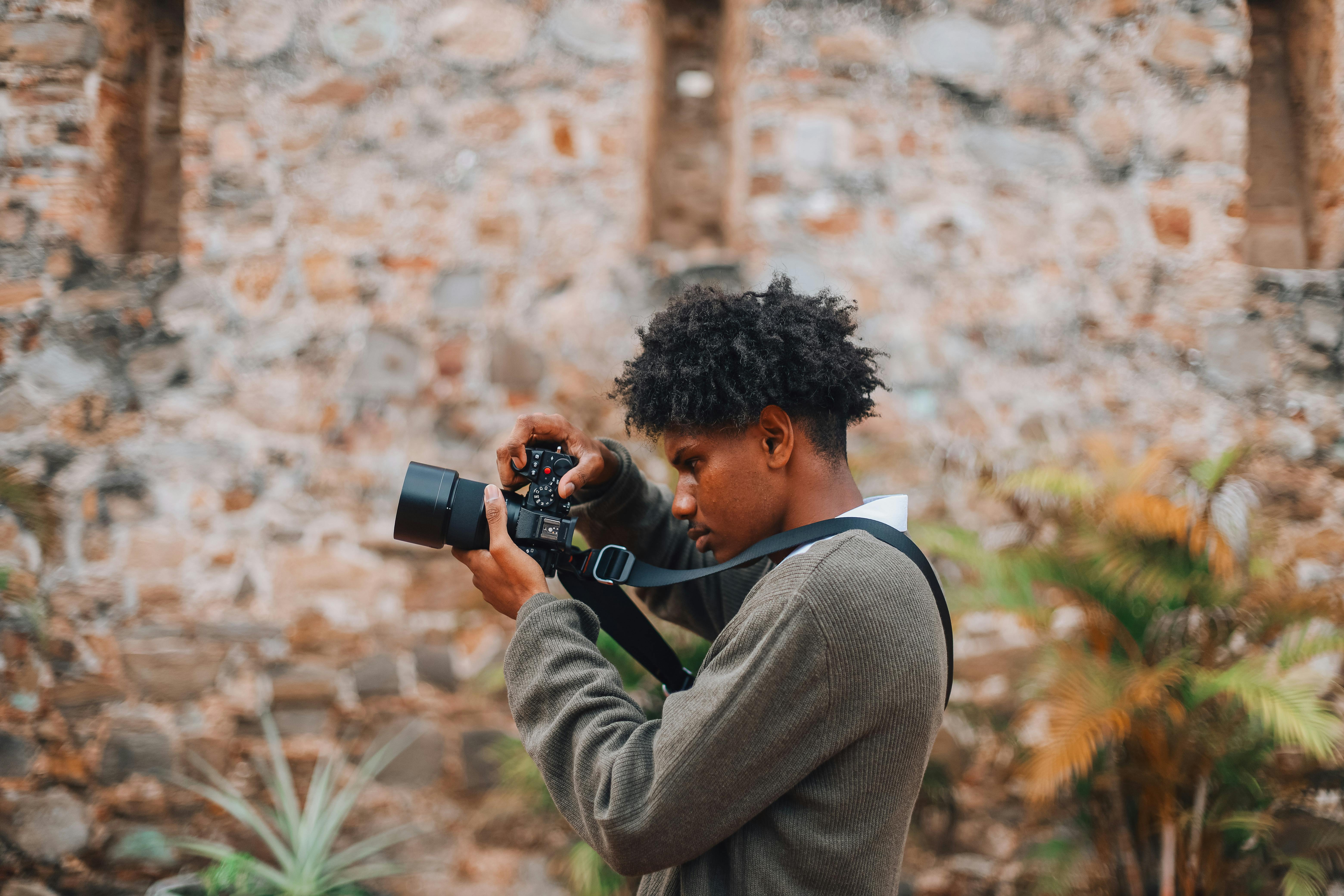 Person Holding Black Dslr Camera · Free Stock Photo