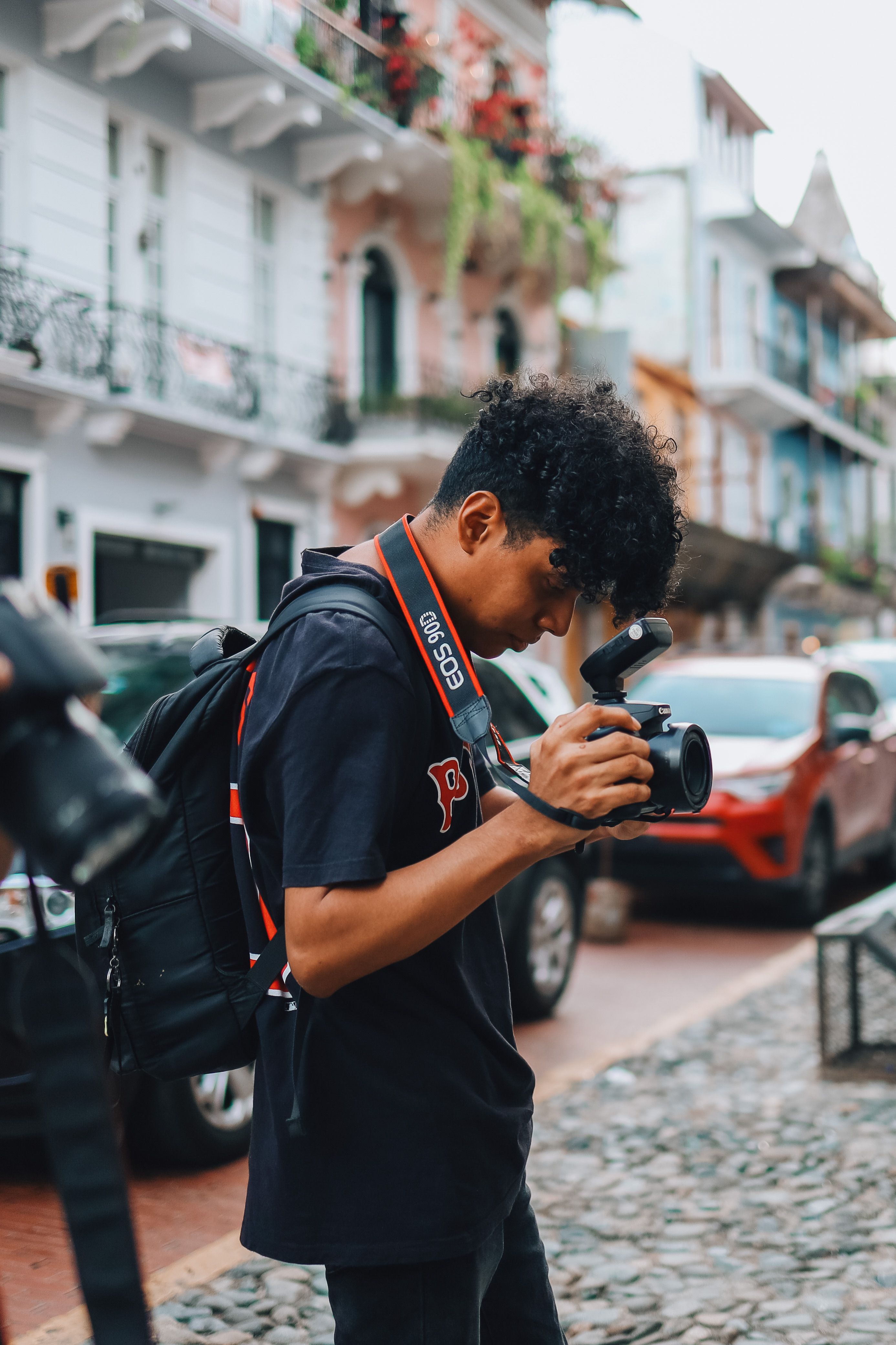 Young Woman Taking a Picture with a Camera on a Sidewalk · Free Stock Photo