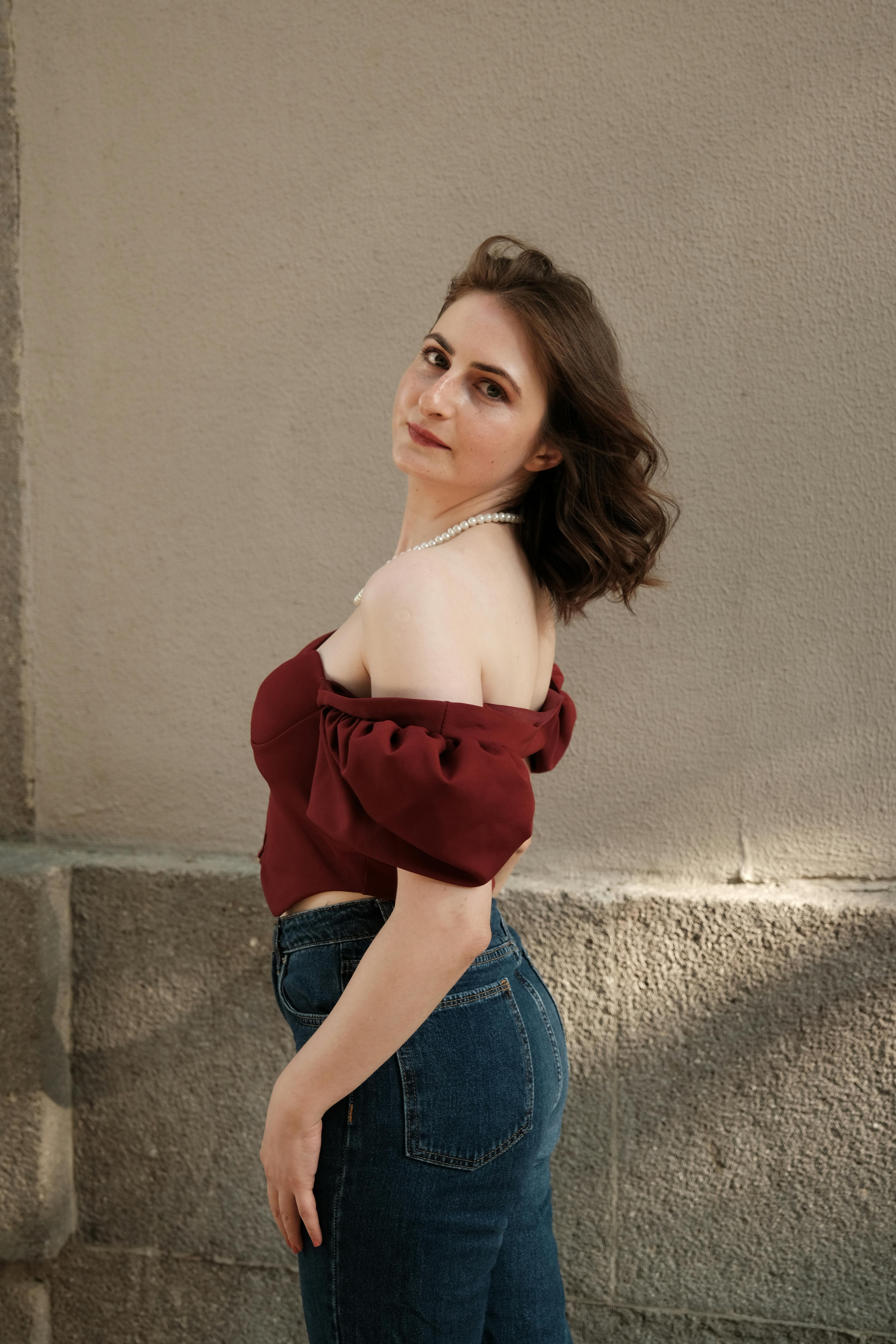 Woman in Top Standing by Wall · Free Stock Photo